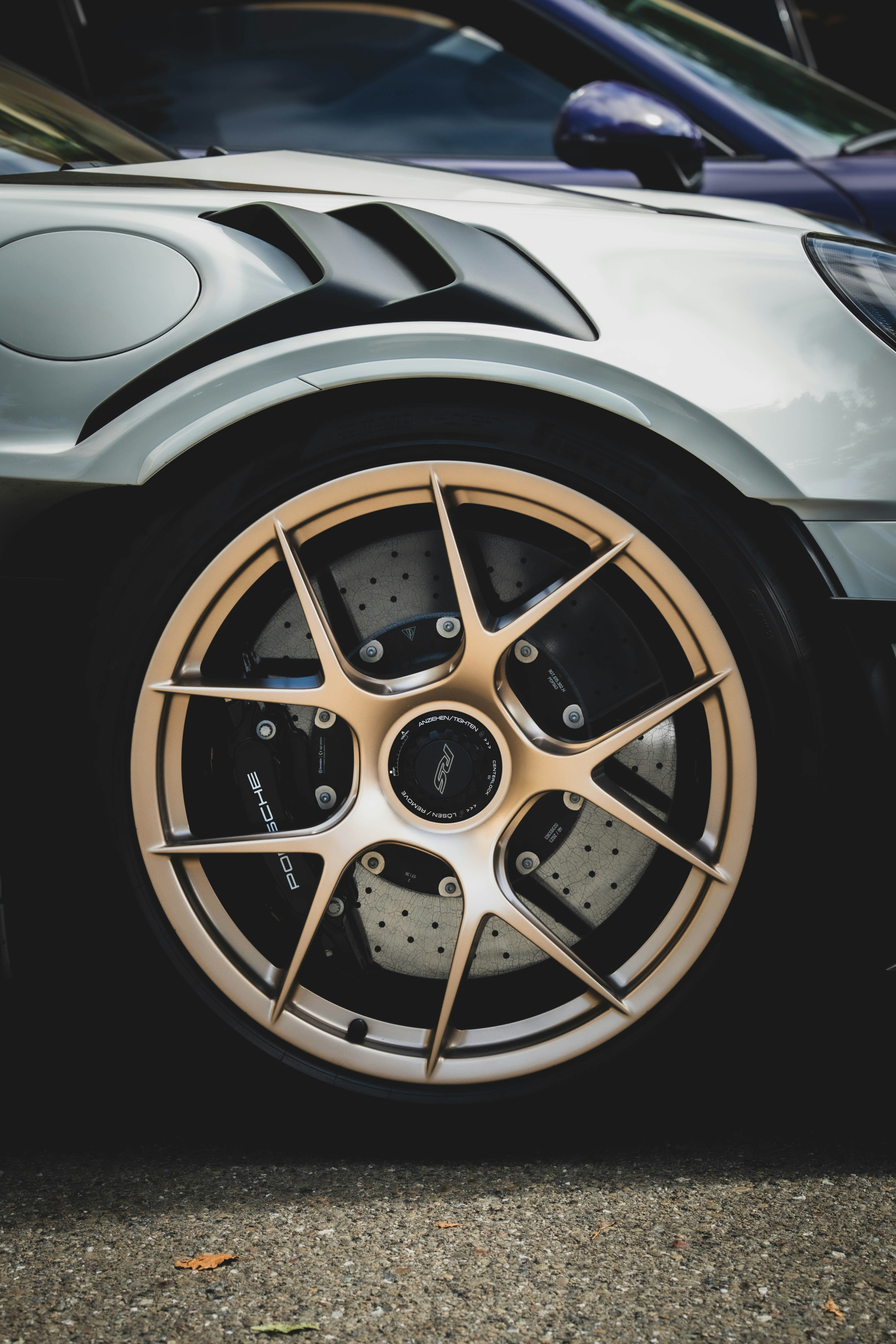 Close-up of a gold sports car wheel with brakes.