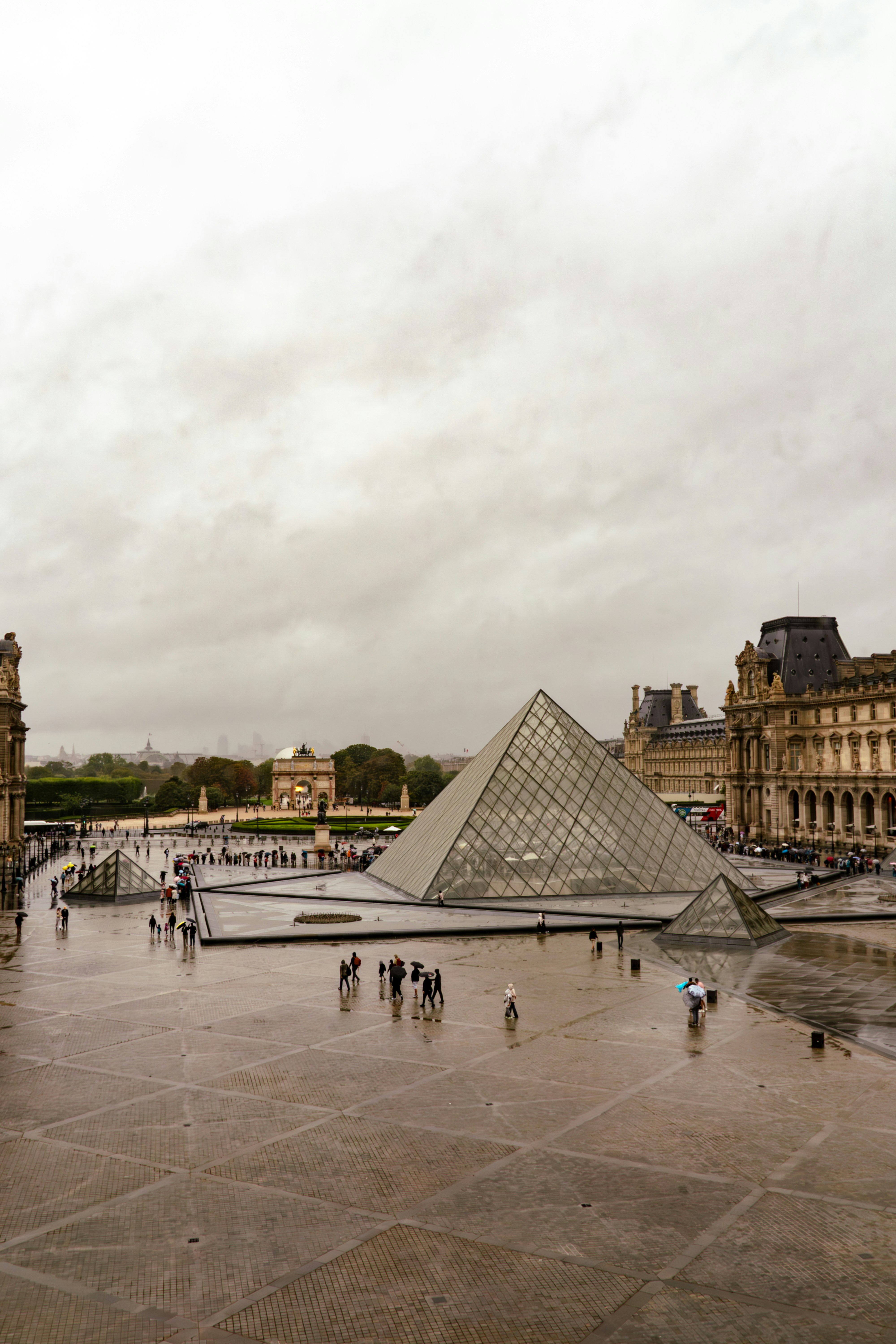 Louvre Museum, Paris, France | Louvre pyramid and museum courtyard on a cloudy day