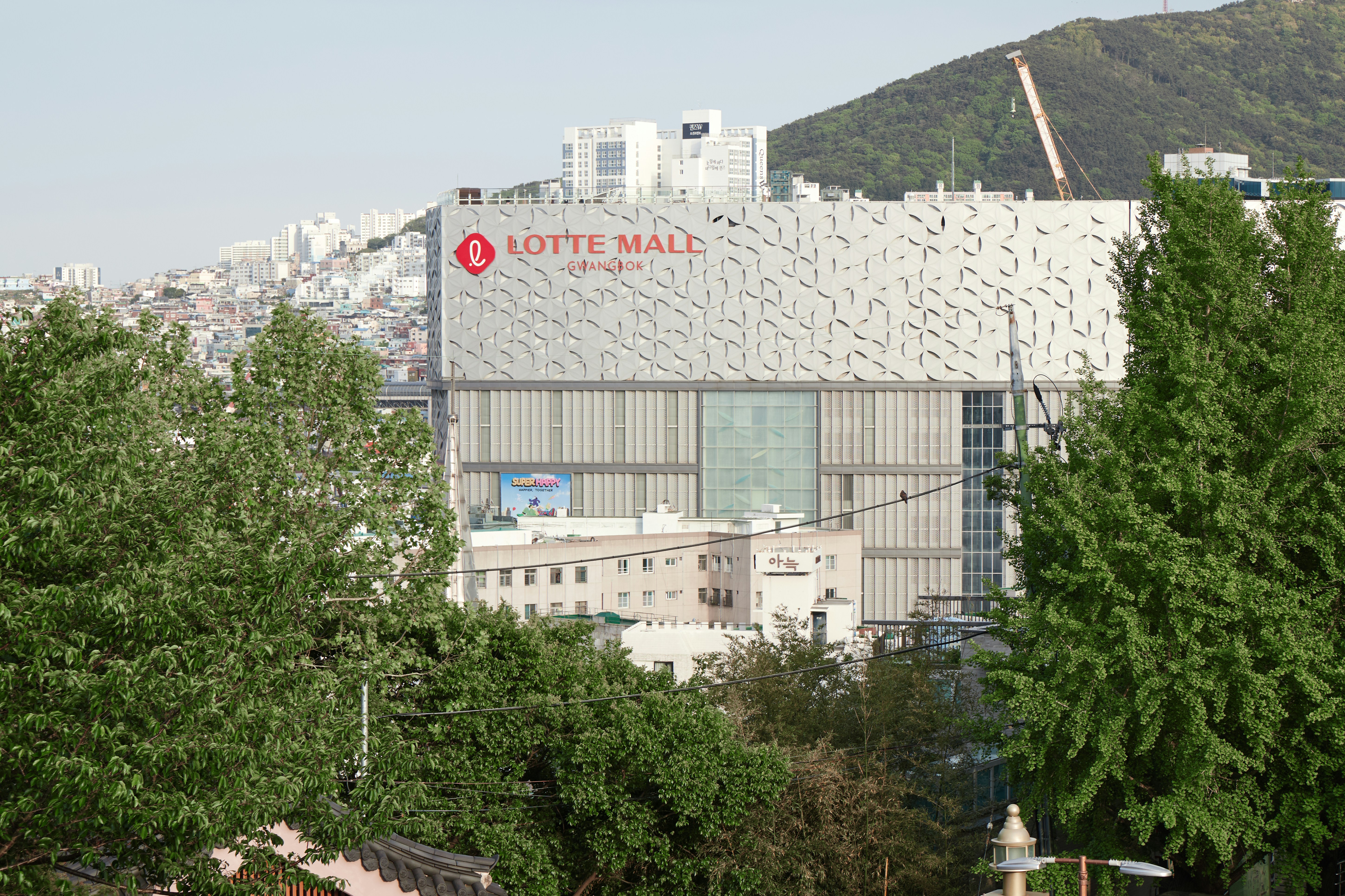 Modern lotte mall building with trees in foreground