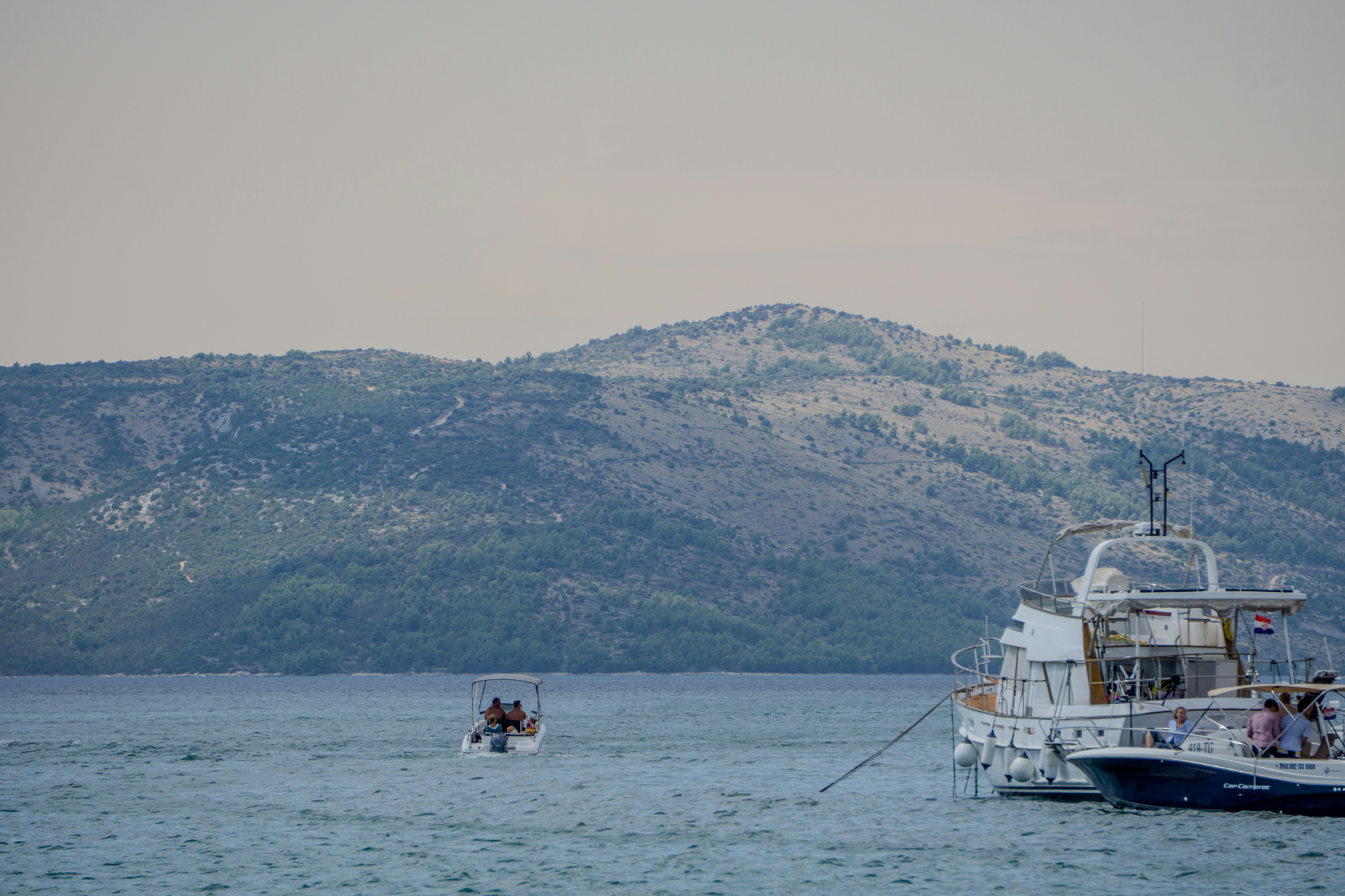 Boats at the Quiet Cove: A Seascape with Distant Hills