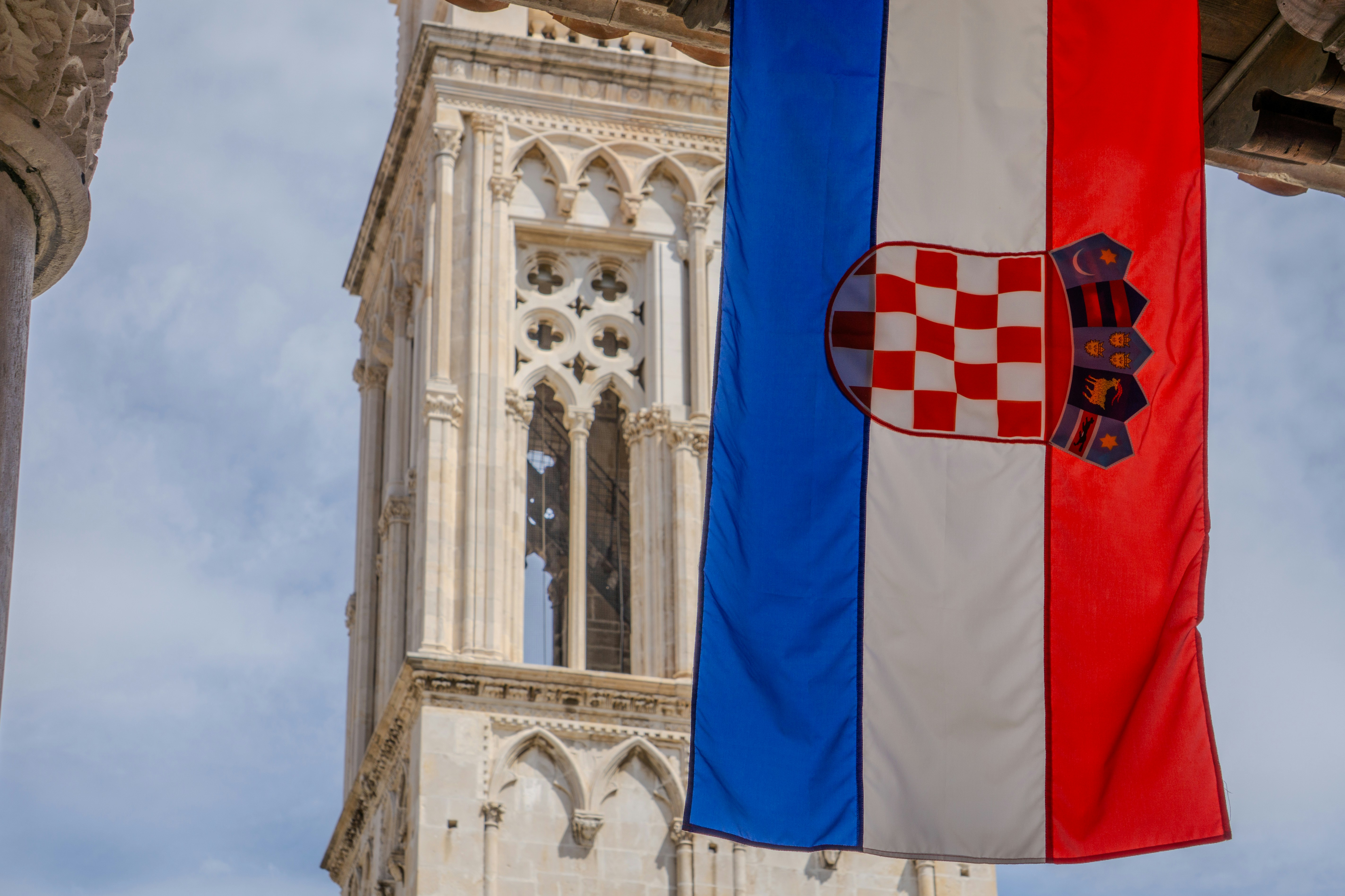 Heritage in Motion: The Croatian Flag Against Historic Architecture