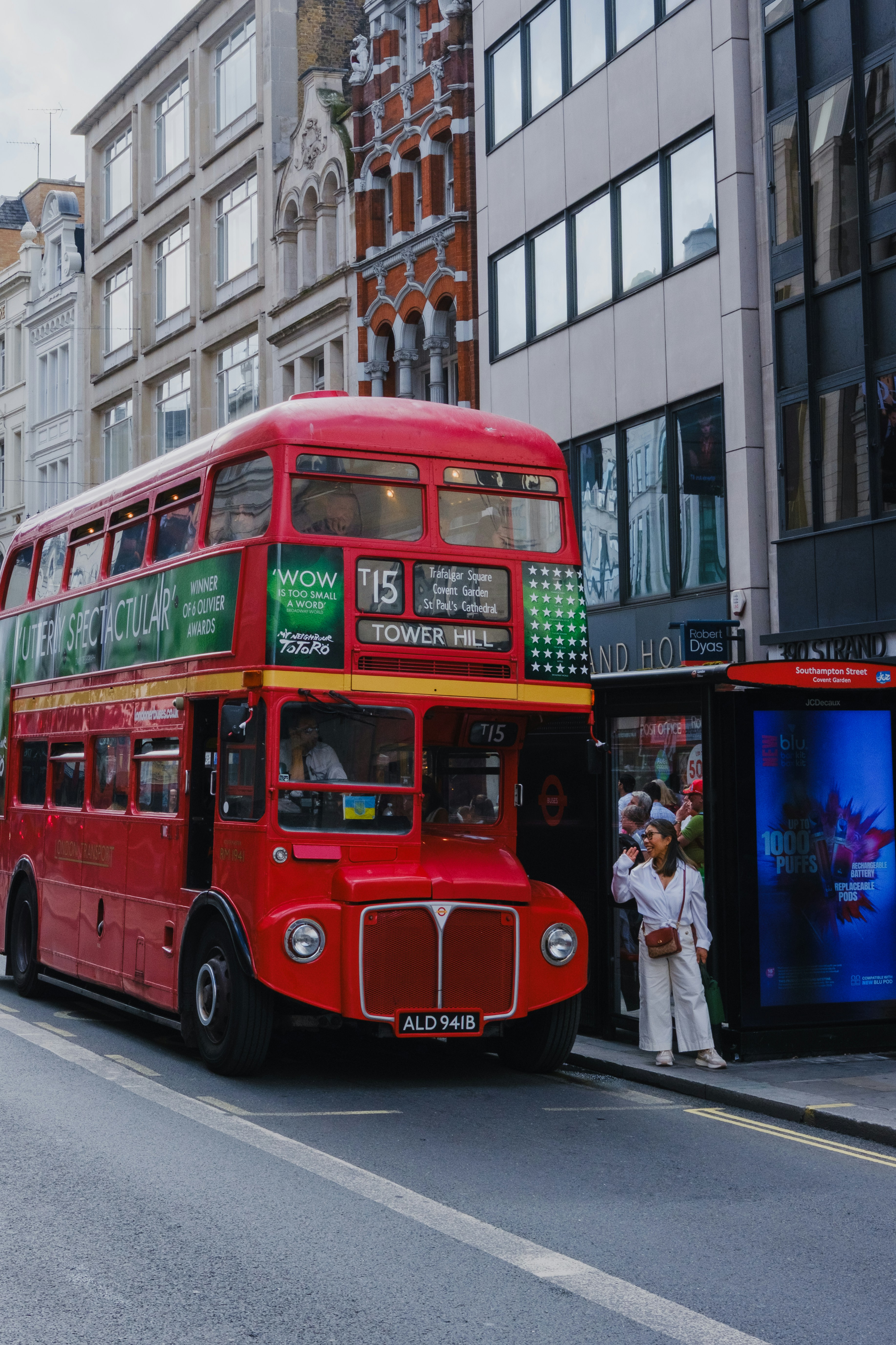 A red double-decker bus on a city street.