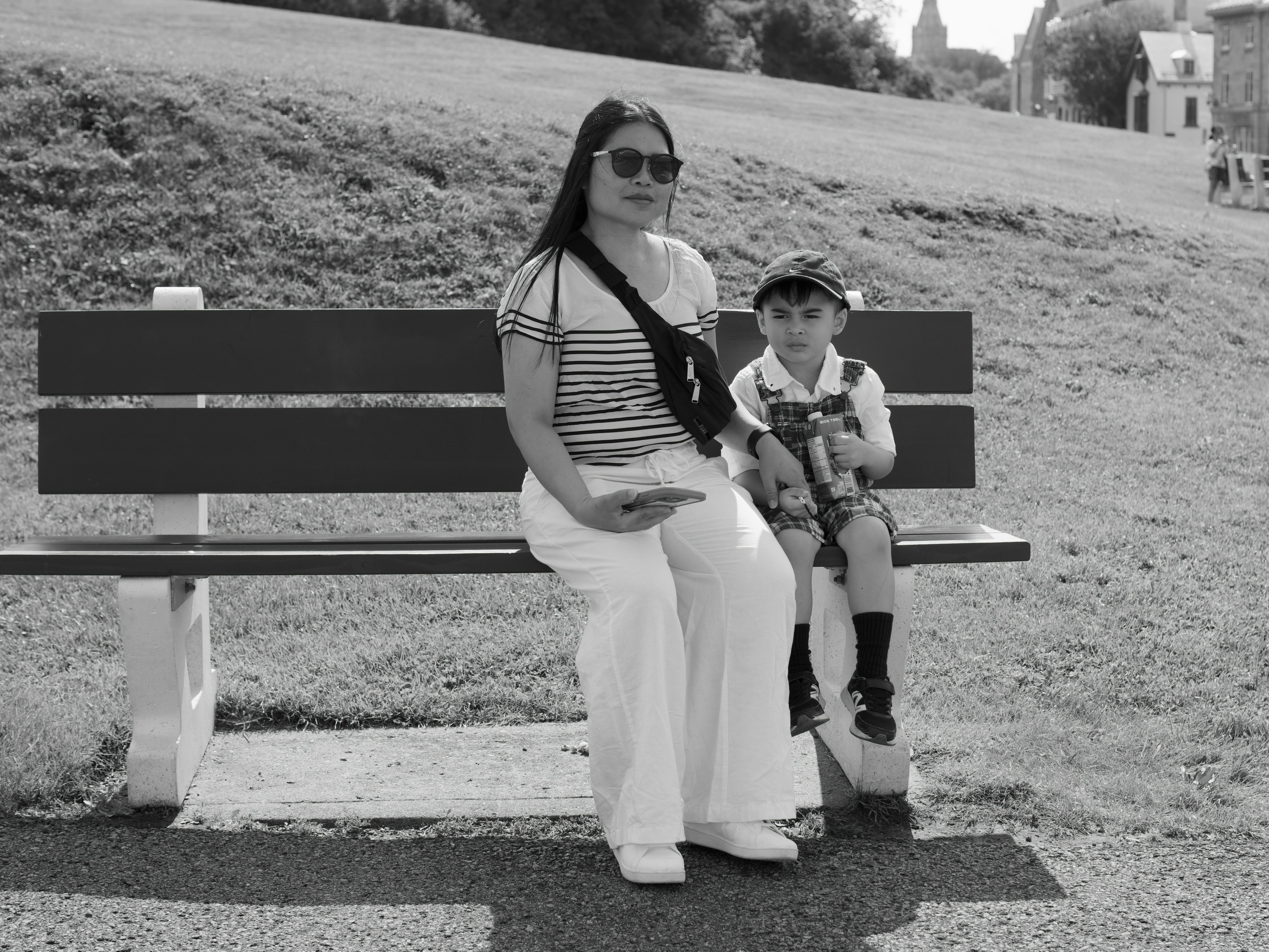 Woman and child sitting on park bench