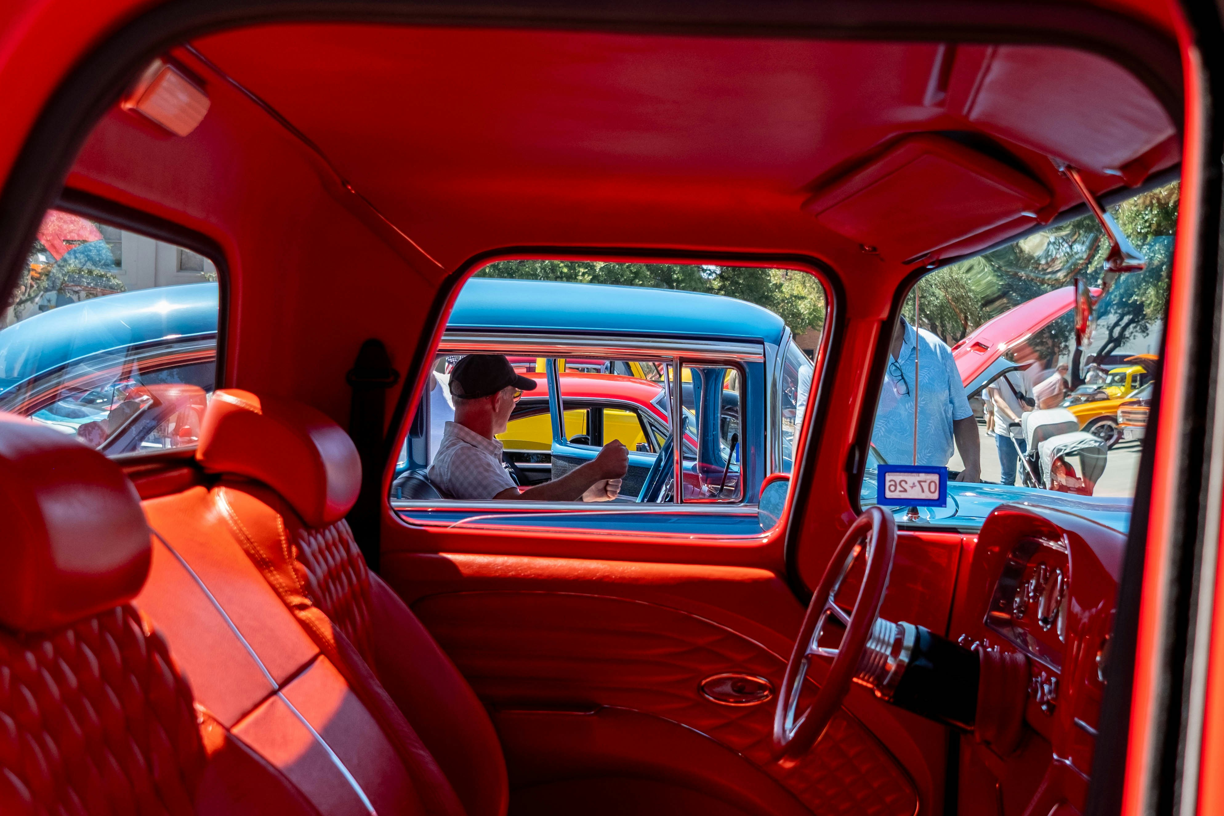 Man driving vintage red truck interior