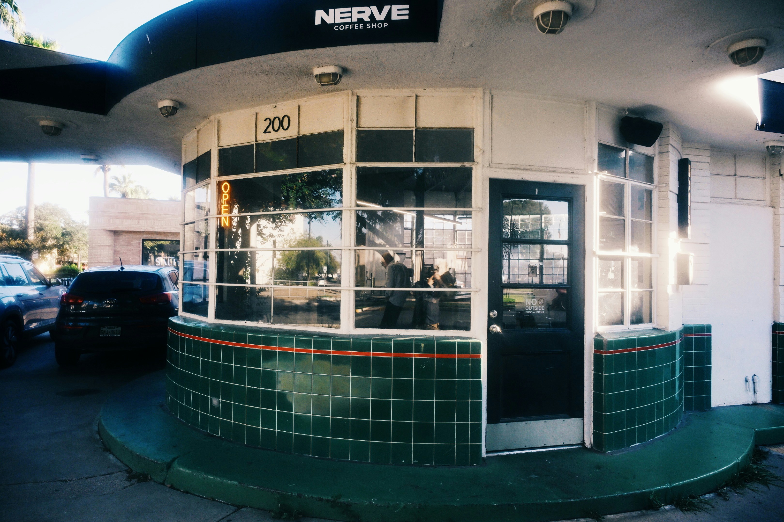 Retro drive-thru building with green tiled accents