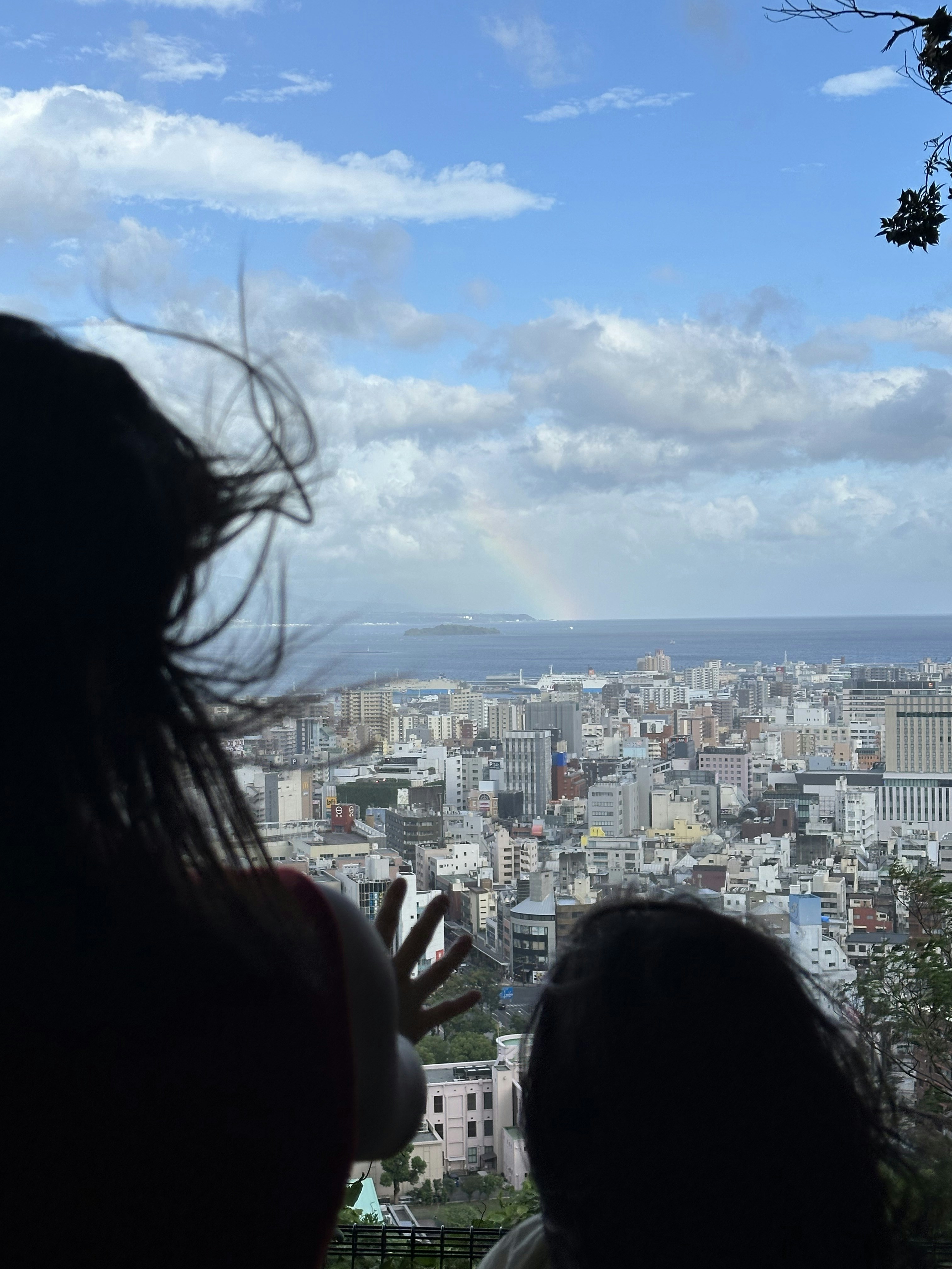 Urban Vista: A Glimpse of City Life Under a Rainbow