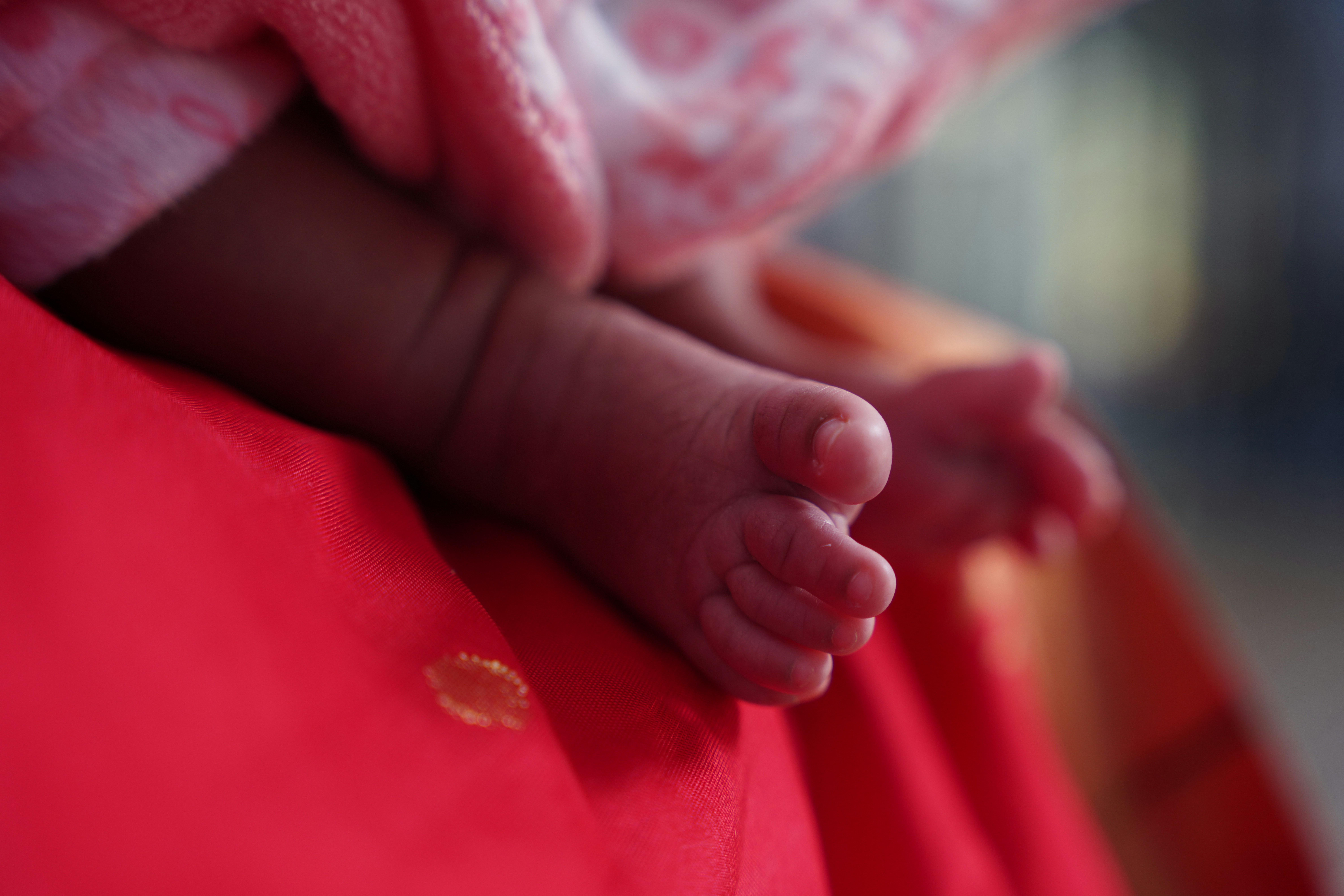 Close up of a newborn baby's tiny feet.
