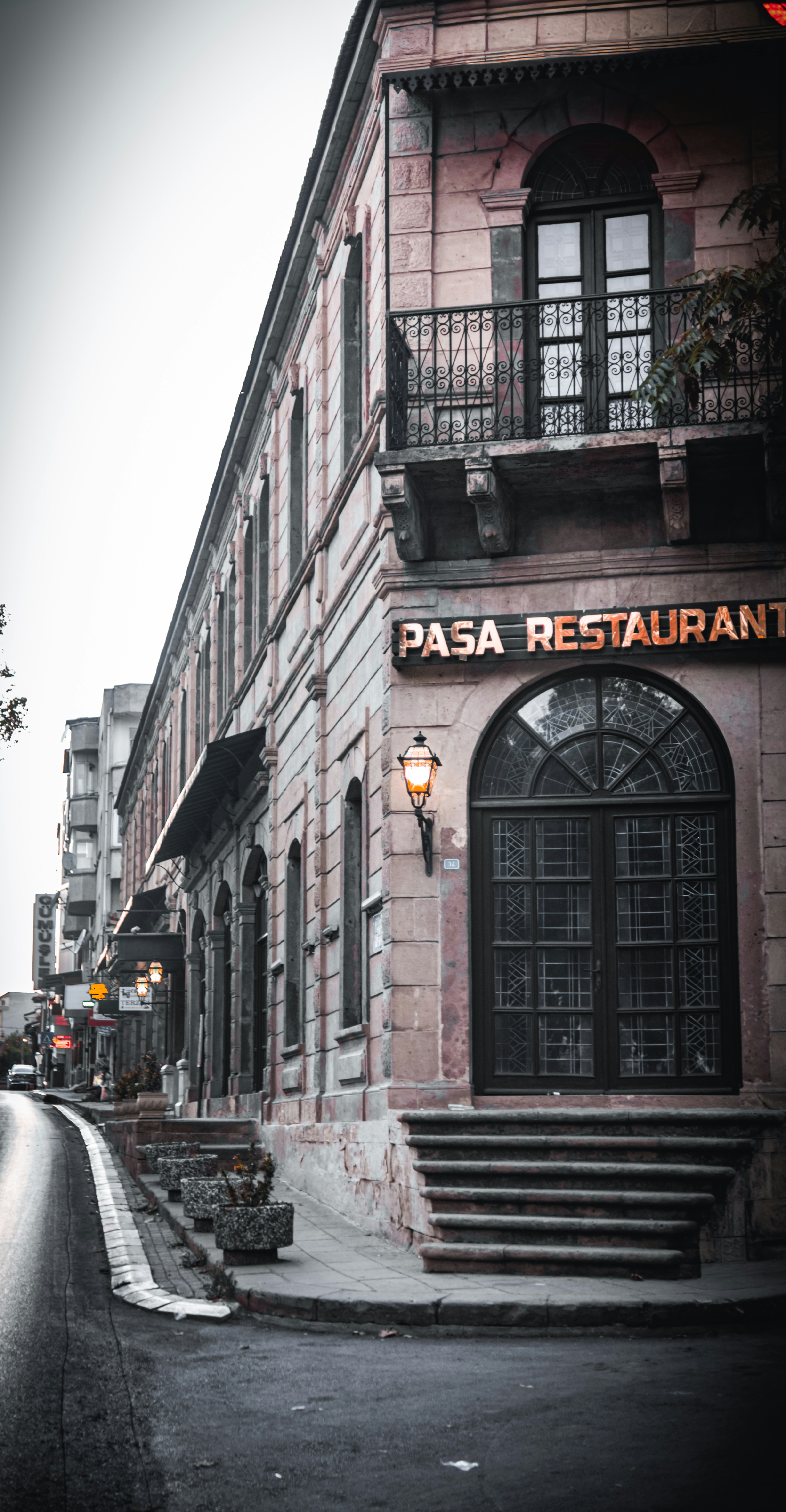Elegant restaurant facade featuring vintage architecture and warm lighting, set against a softly lit street. The inviting atmosphere suggests a blend of history and contemporary charm.