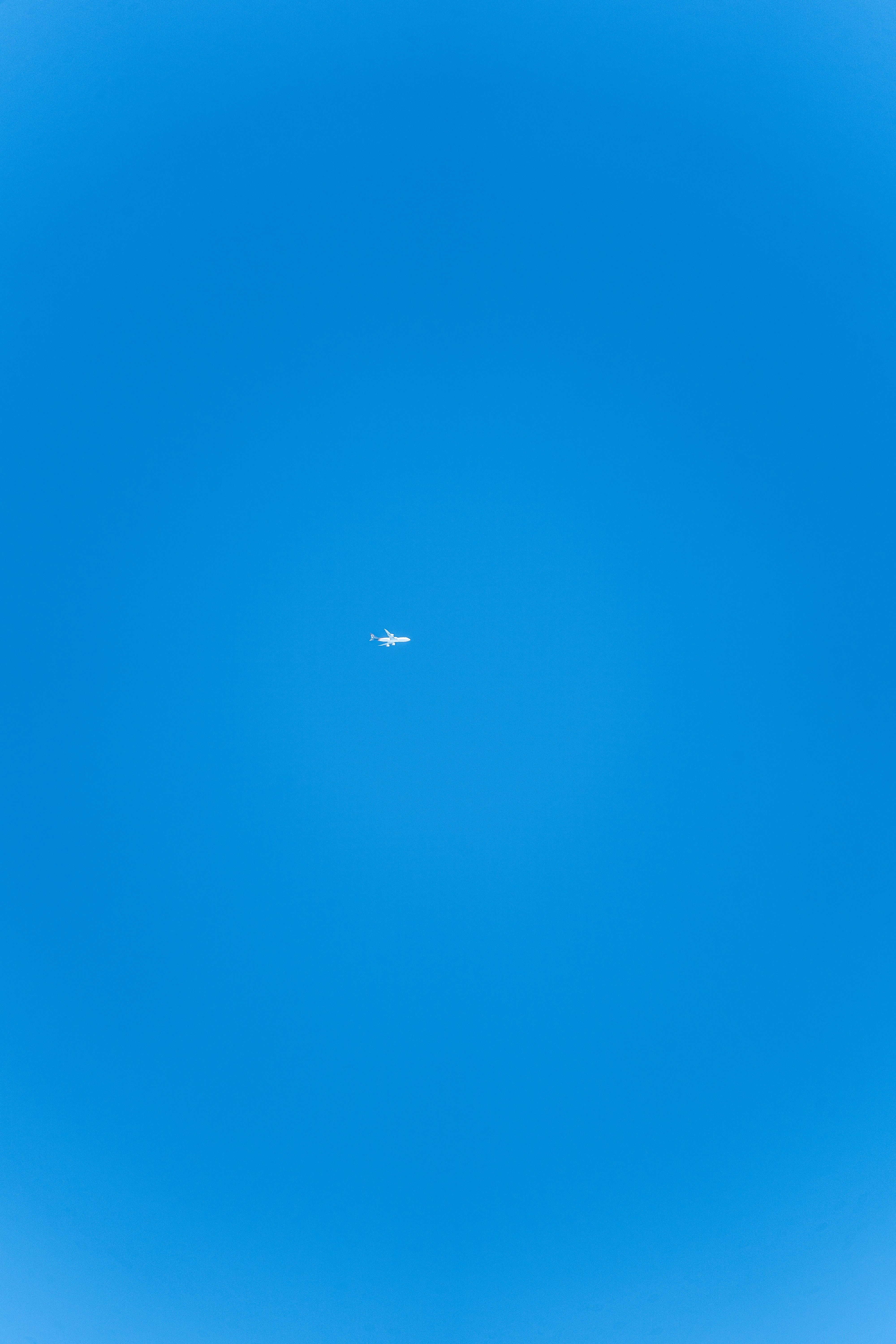 A small airplane flying in a clear blue sky.