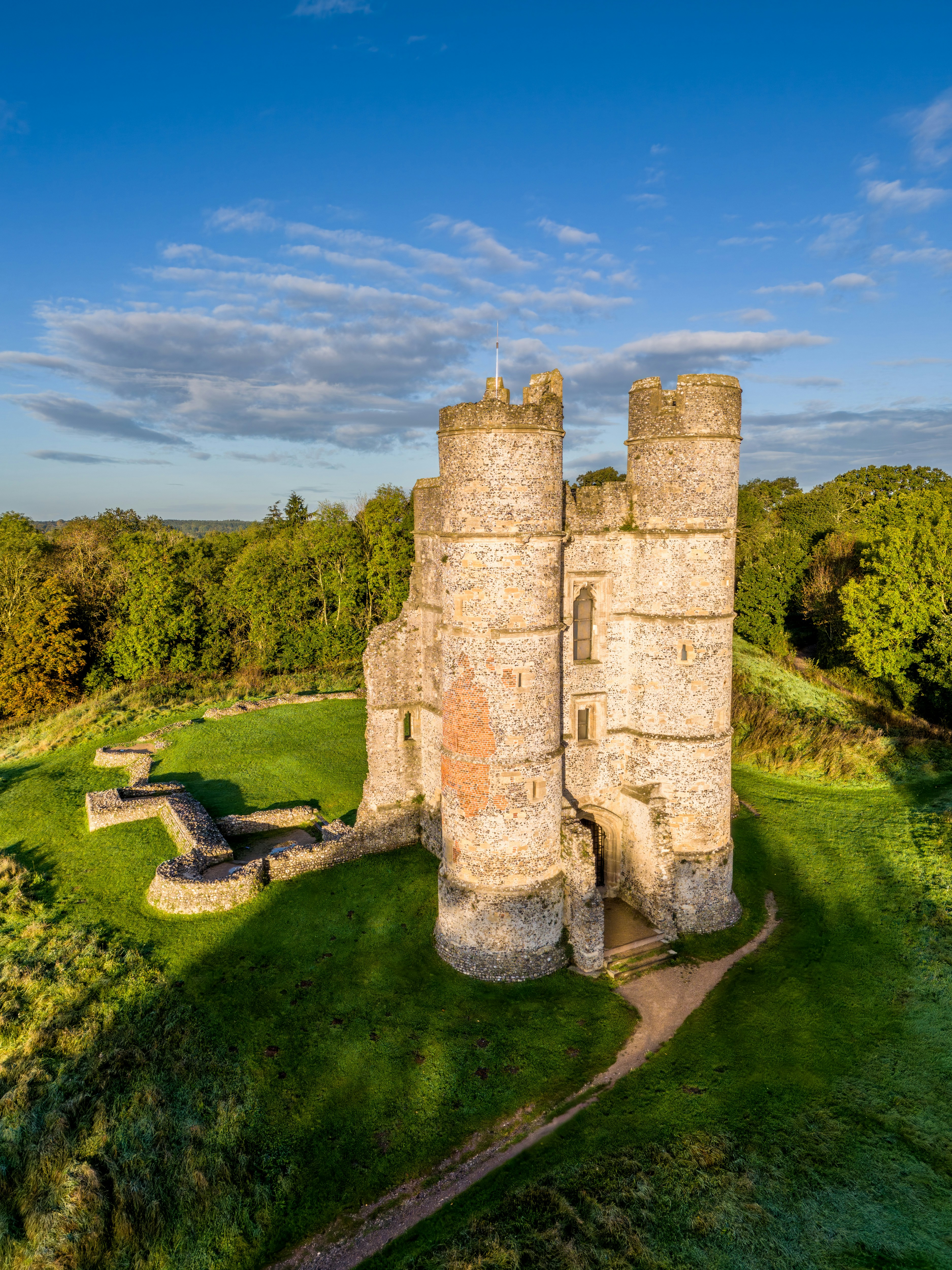 Stone Sentinel: Aerial Portrait of a Sunlit Castle Tower