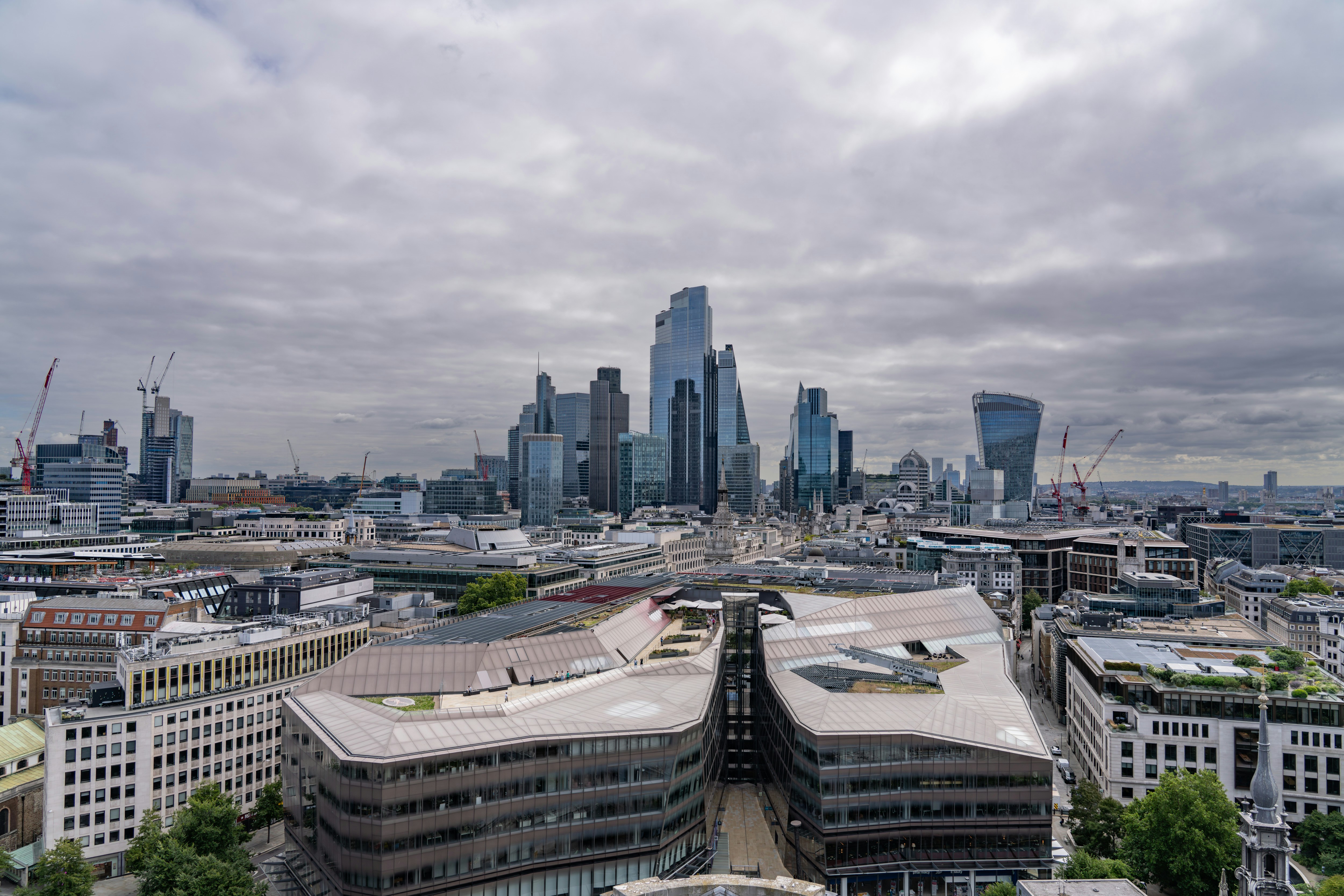 The City of London Skyline and One New Change Shopping Mall | Modern london skyline with contemporary architecture and cloudy sky.