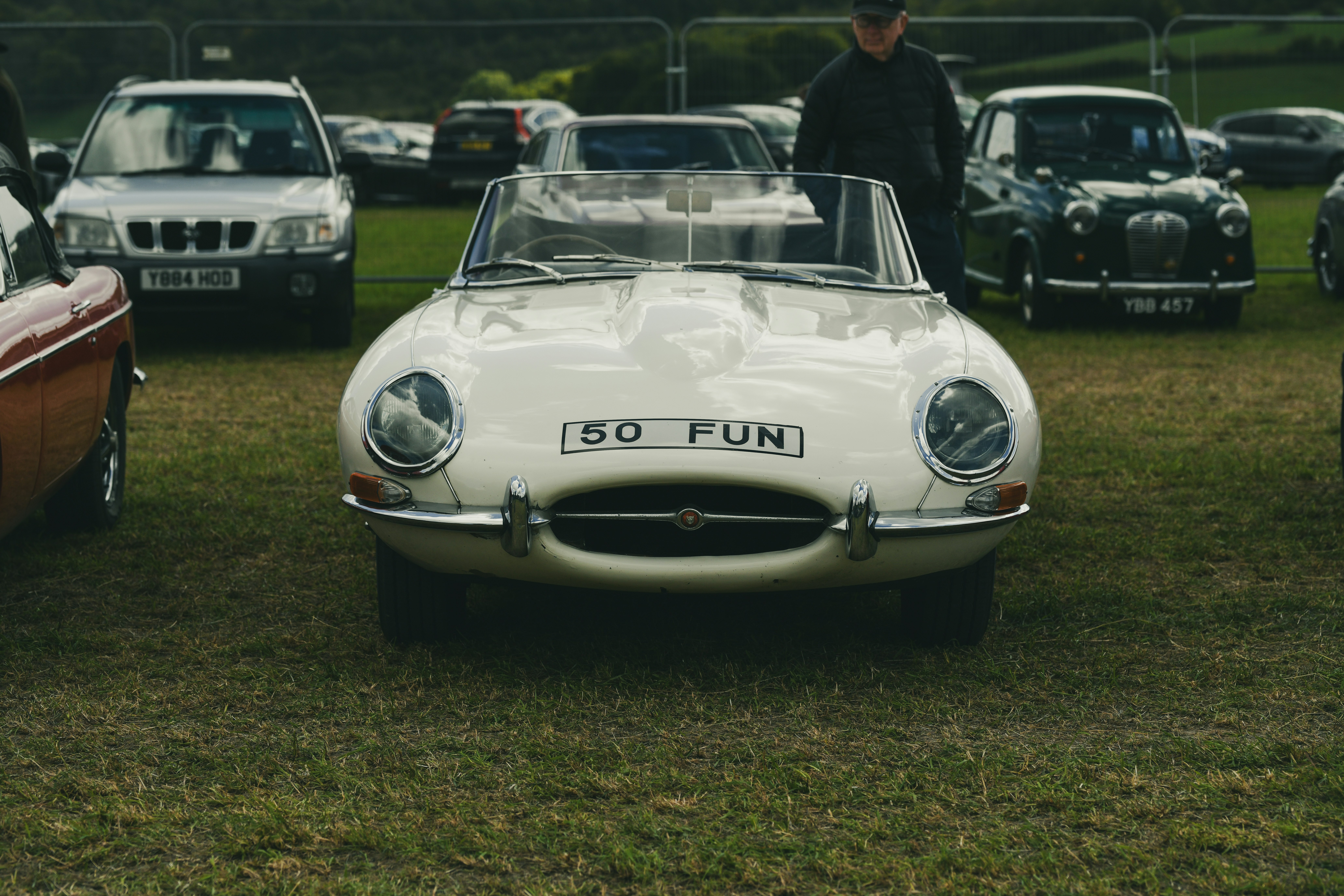 50 Fun in White: A Jaguar E-Type Amid a Vintage Car Gathering