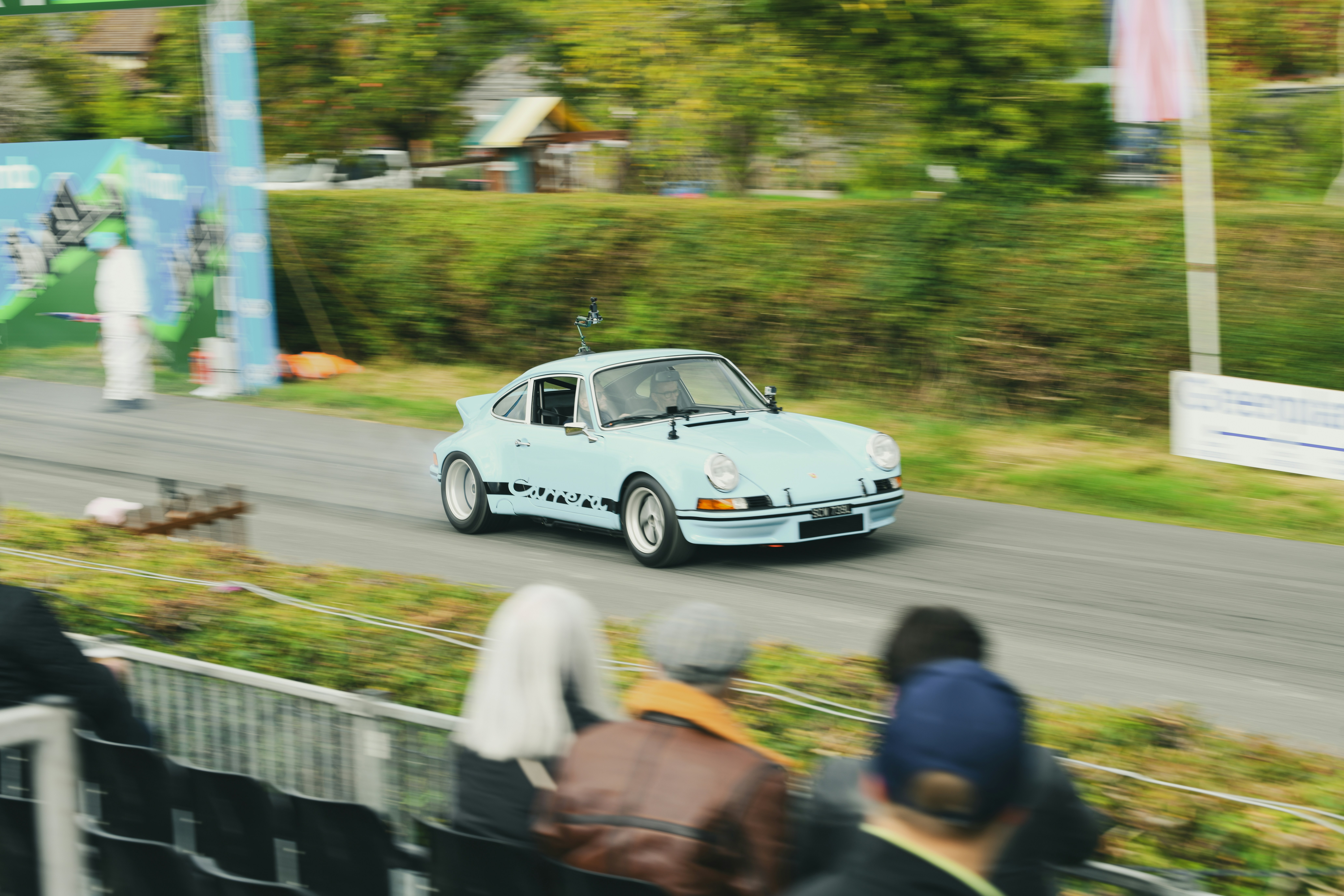 Light blue vintage race car speeding on track