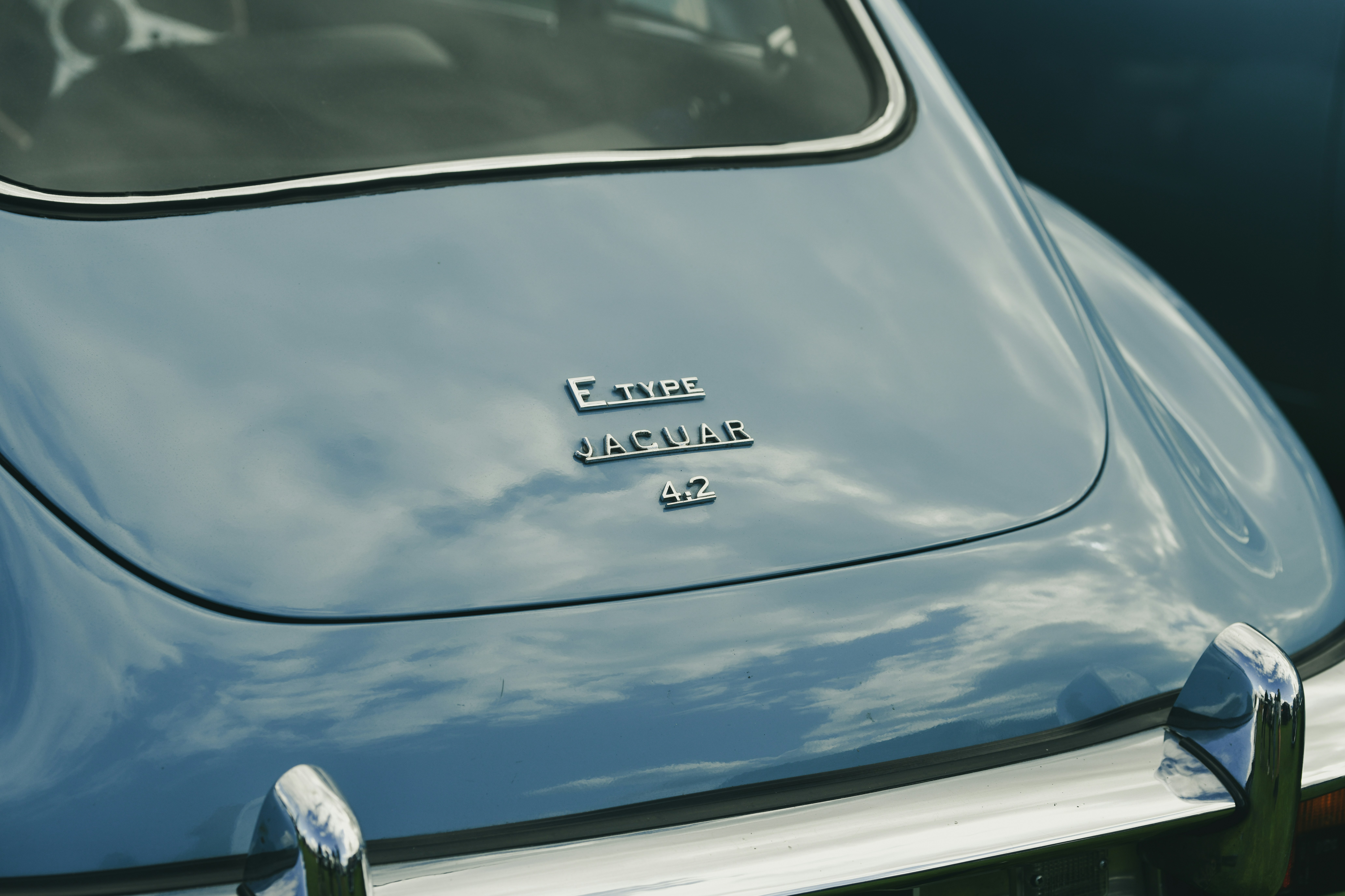 Close-up of a classic light blue jaguar e-type rear.