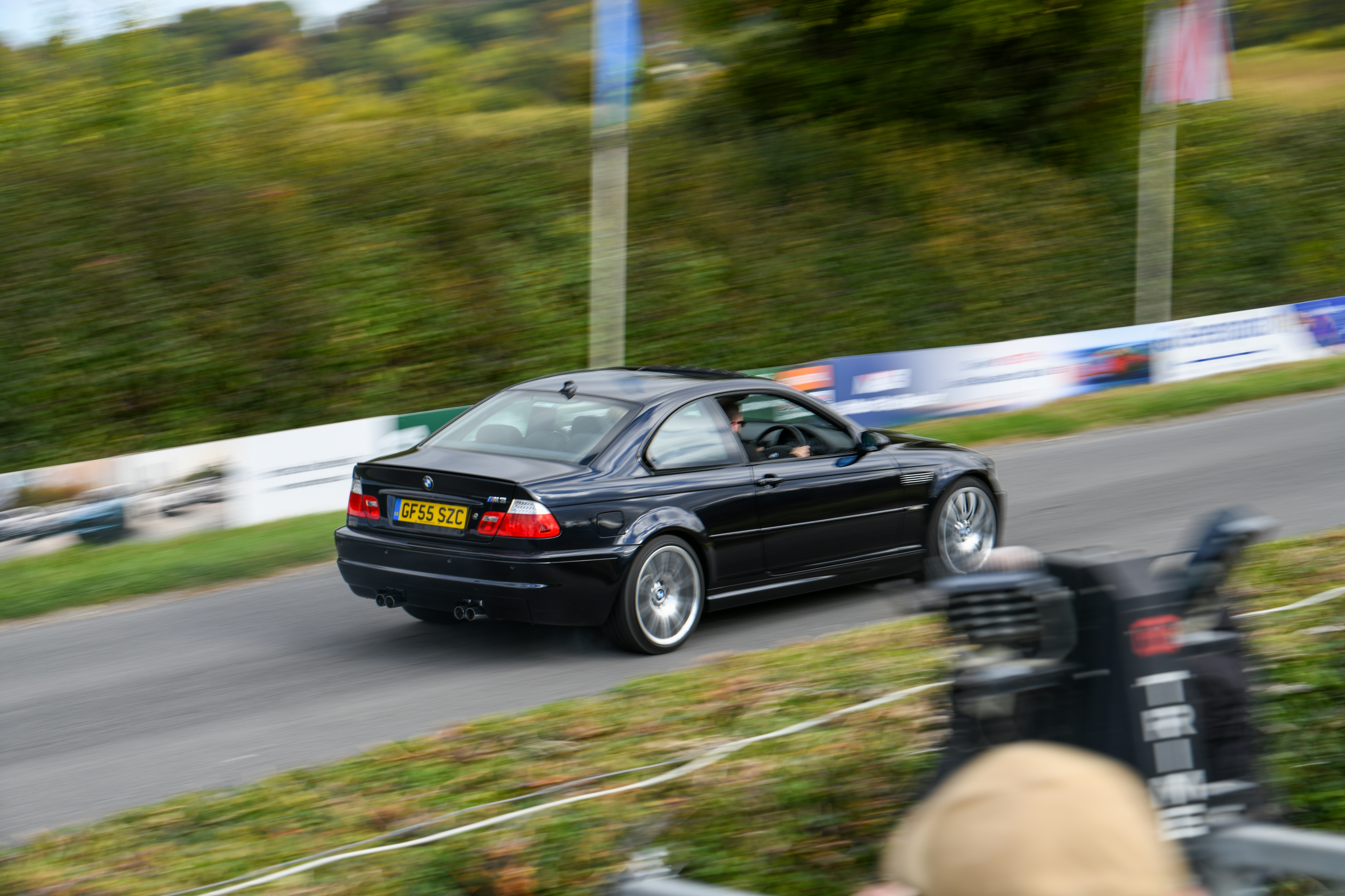 Mid-Track Conquest: A Black Coupe Surges Through Motion Blur