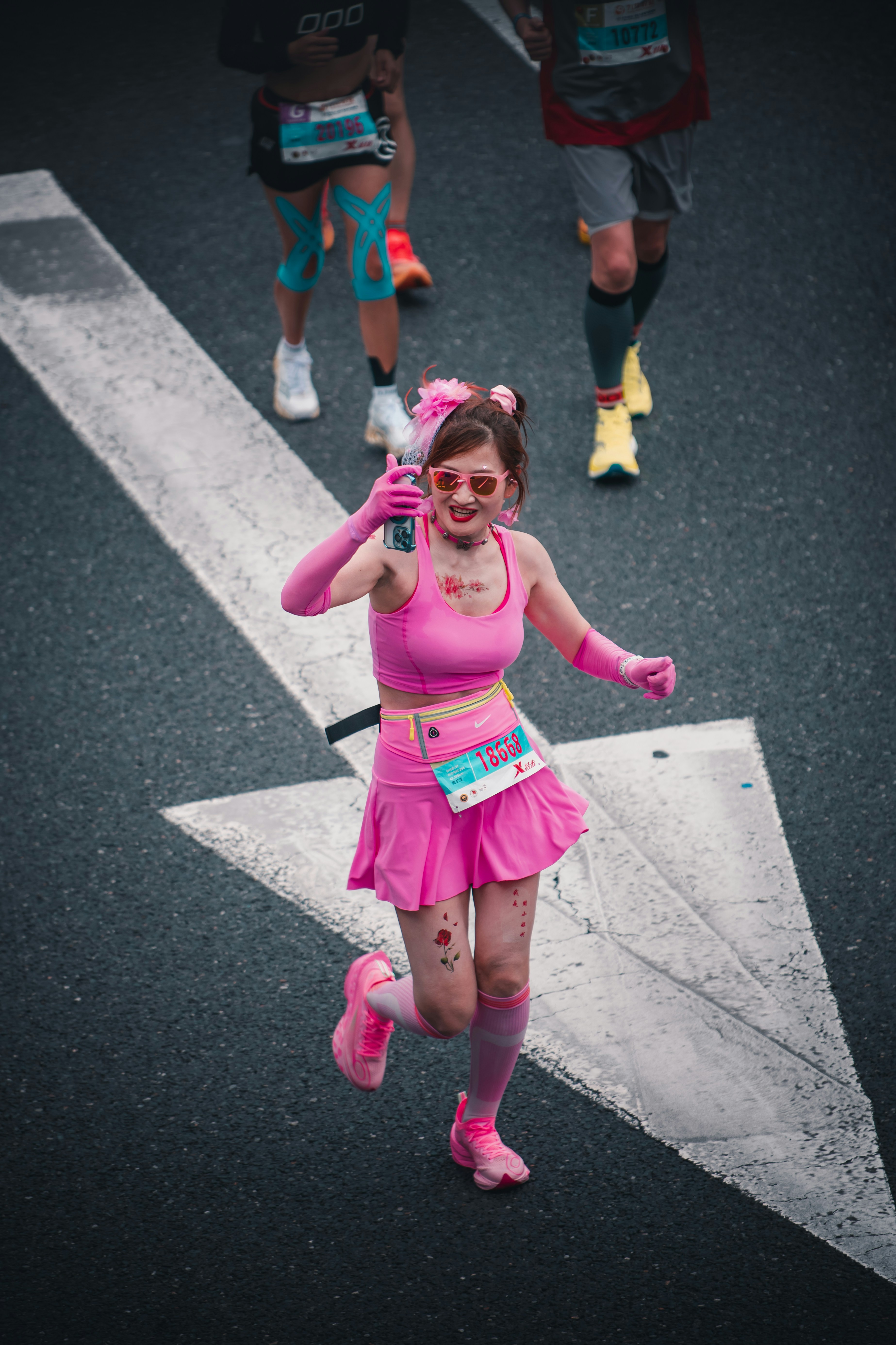 Selfie Moment in Pink: A Playful Marathoner Leads the Urban Race