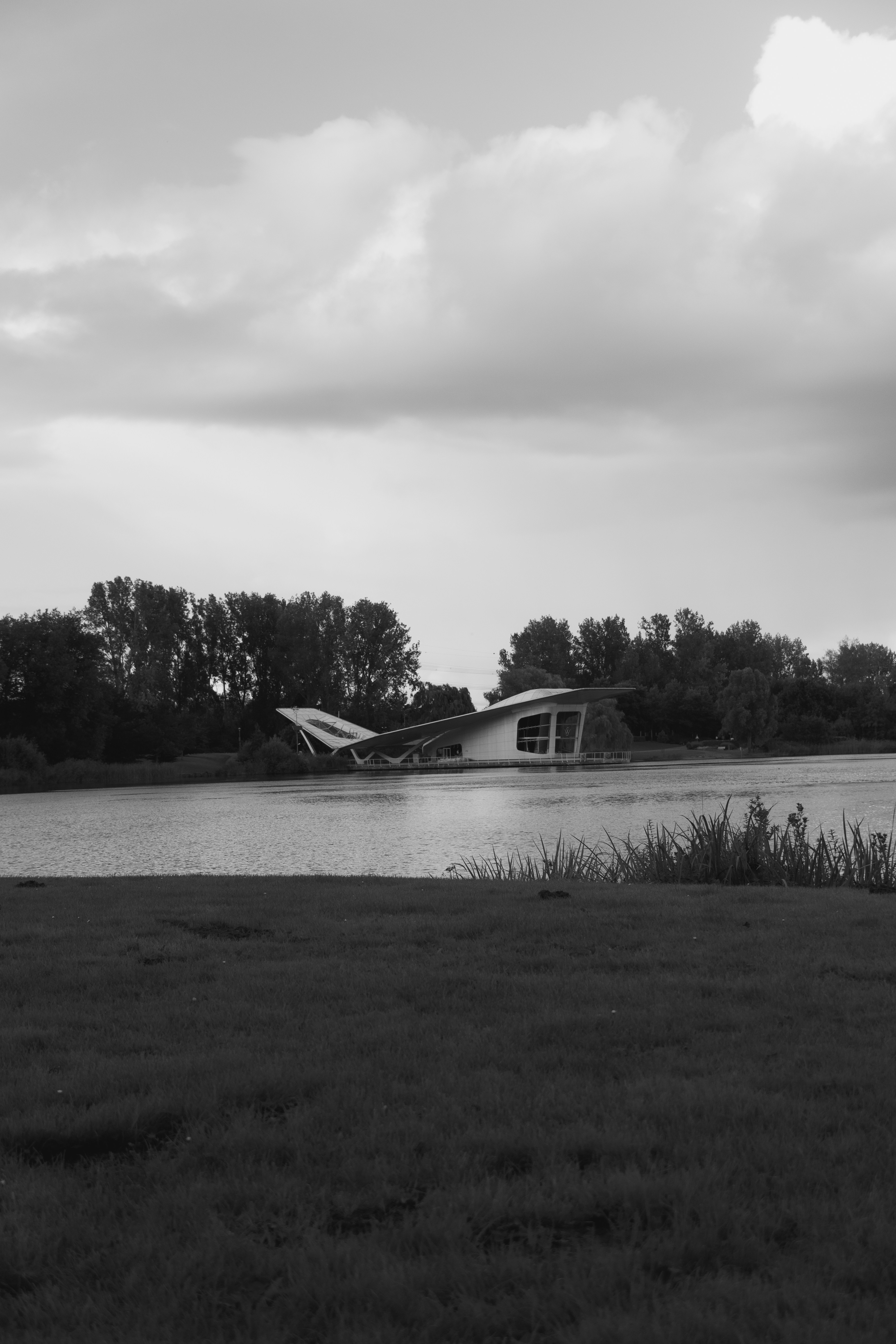Modern building on a lake under cloudy sky
