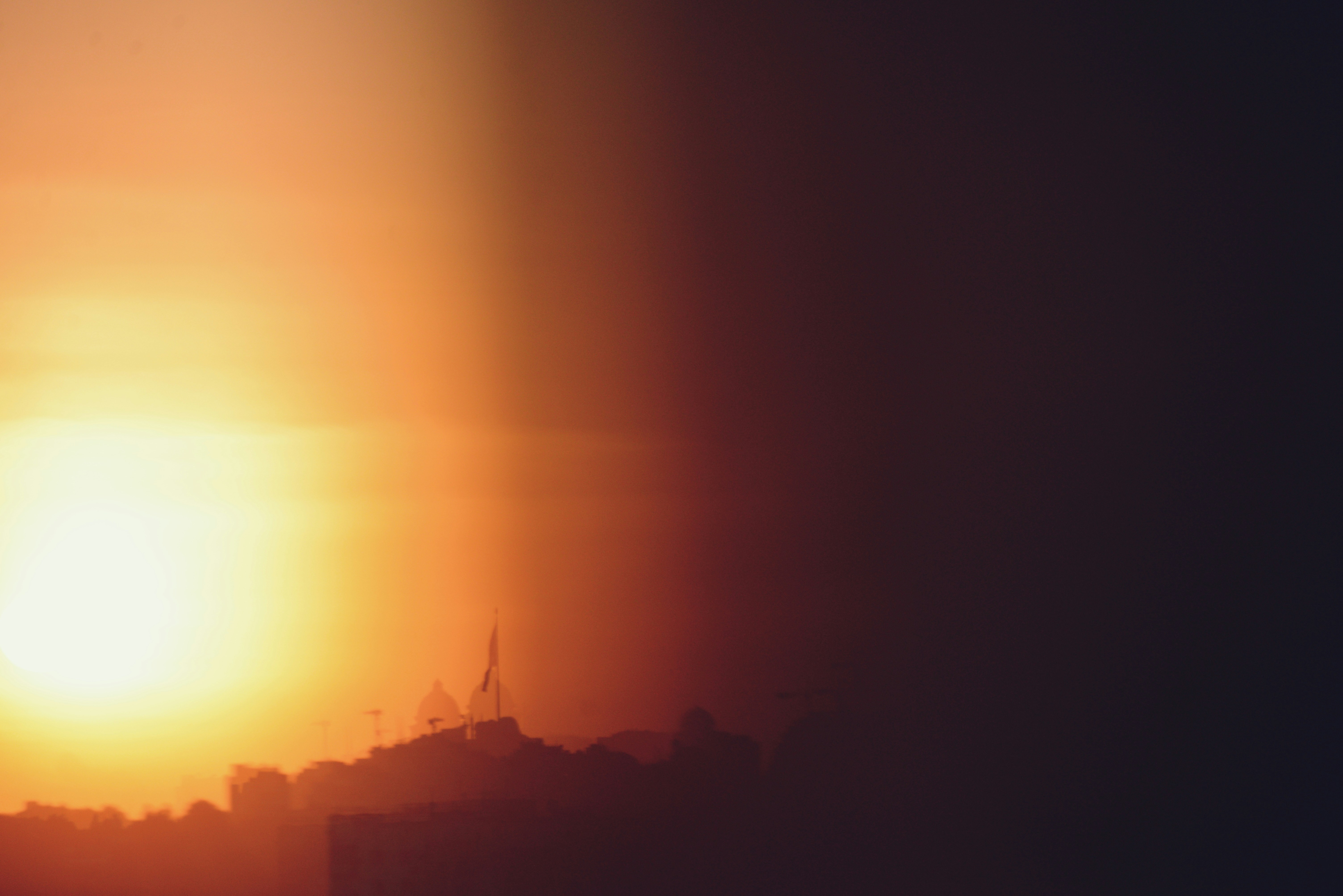 Golden sunset over a silhouetted city skyline