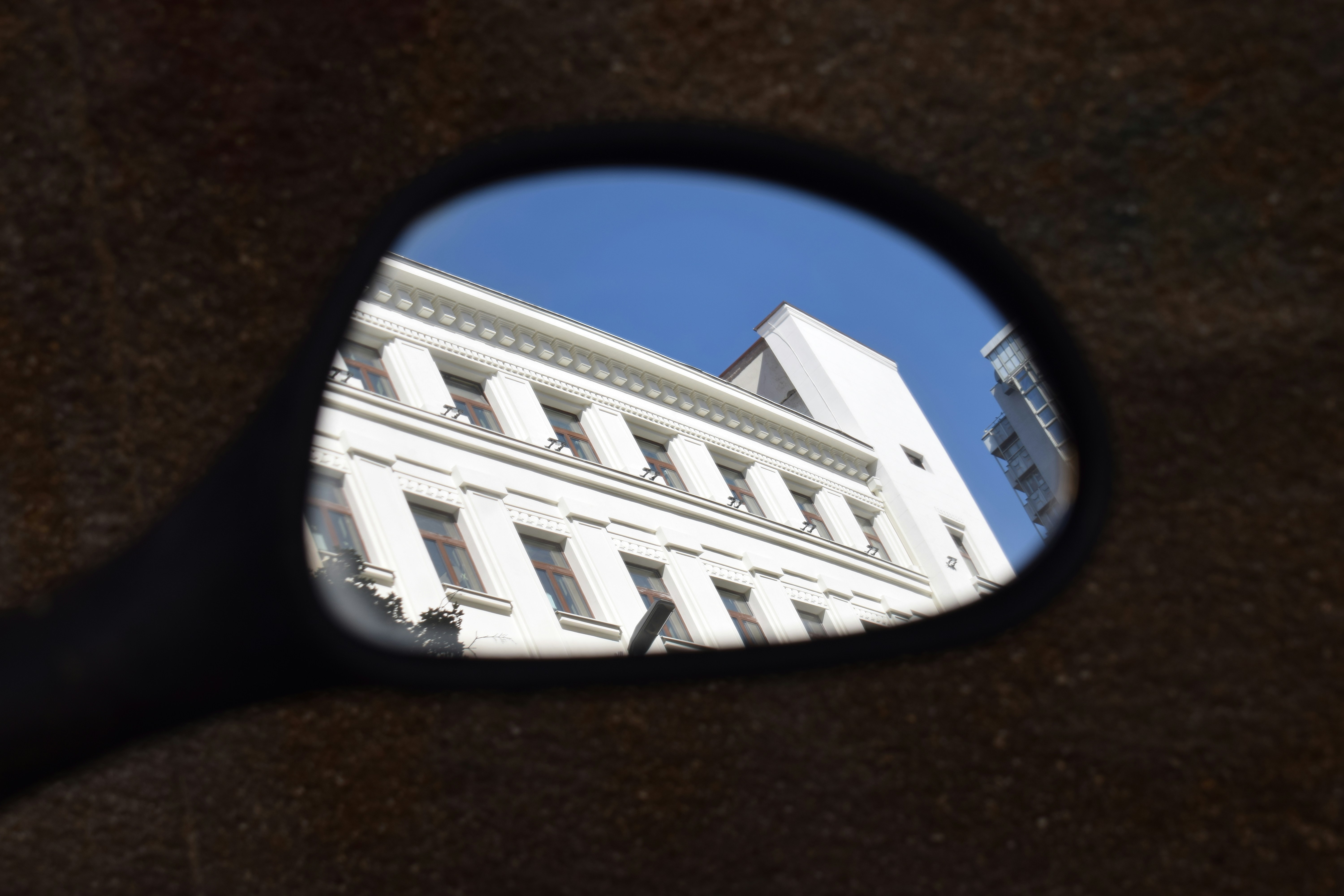 Reflection of a white building in a mirror