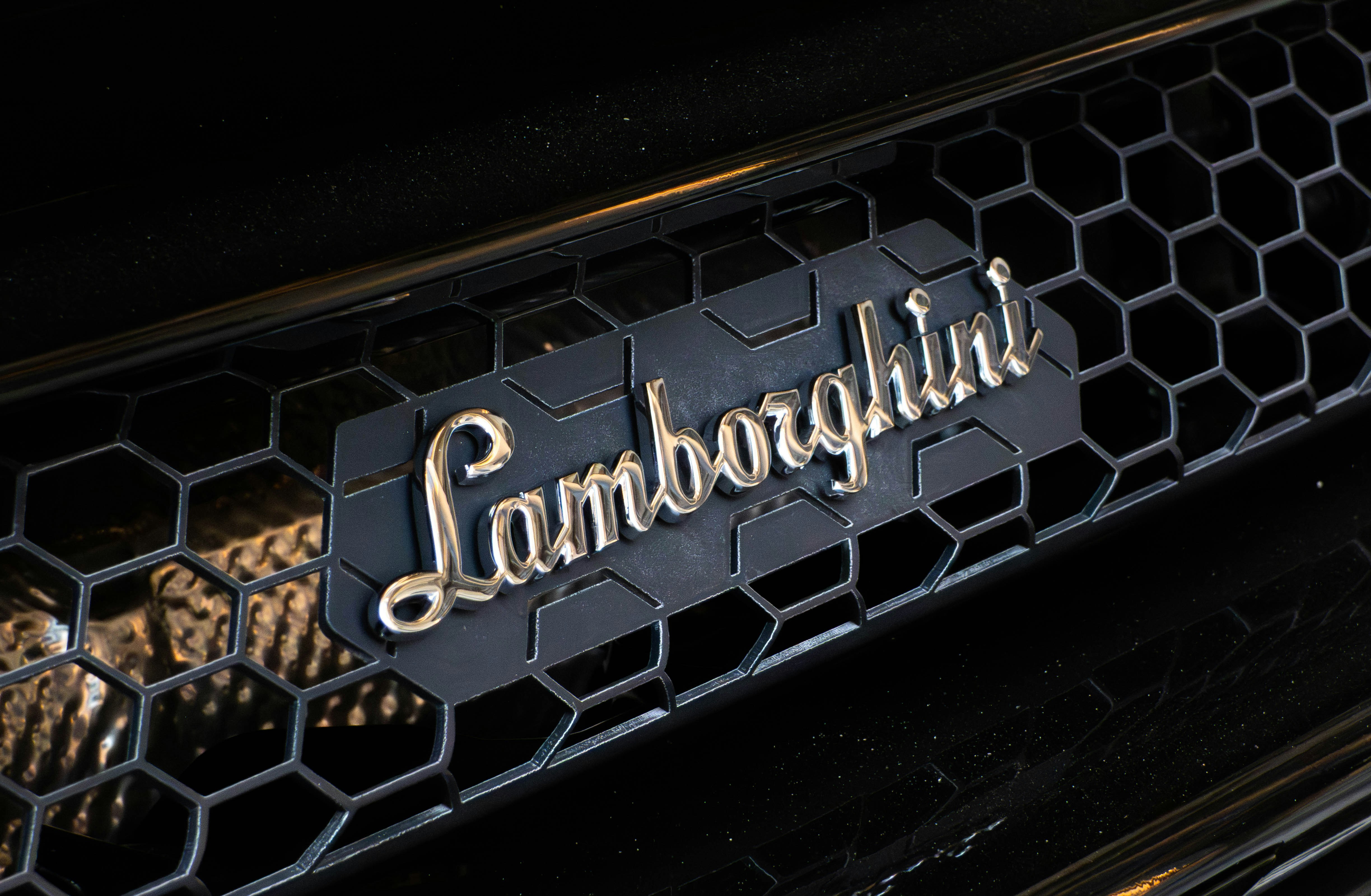 Lamborghini emblem on a black honeycomb grille photo – Free Sports car ...