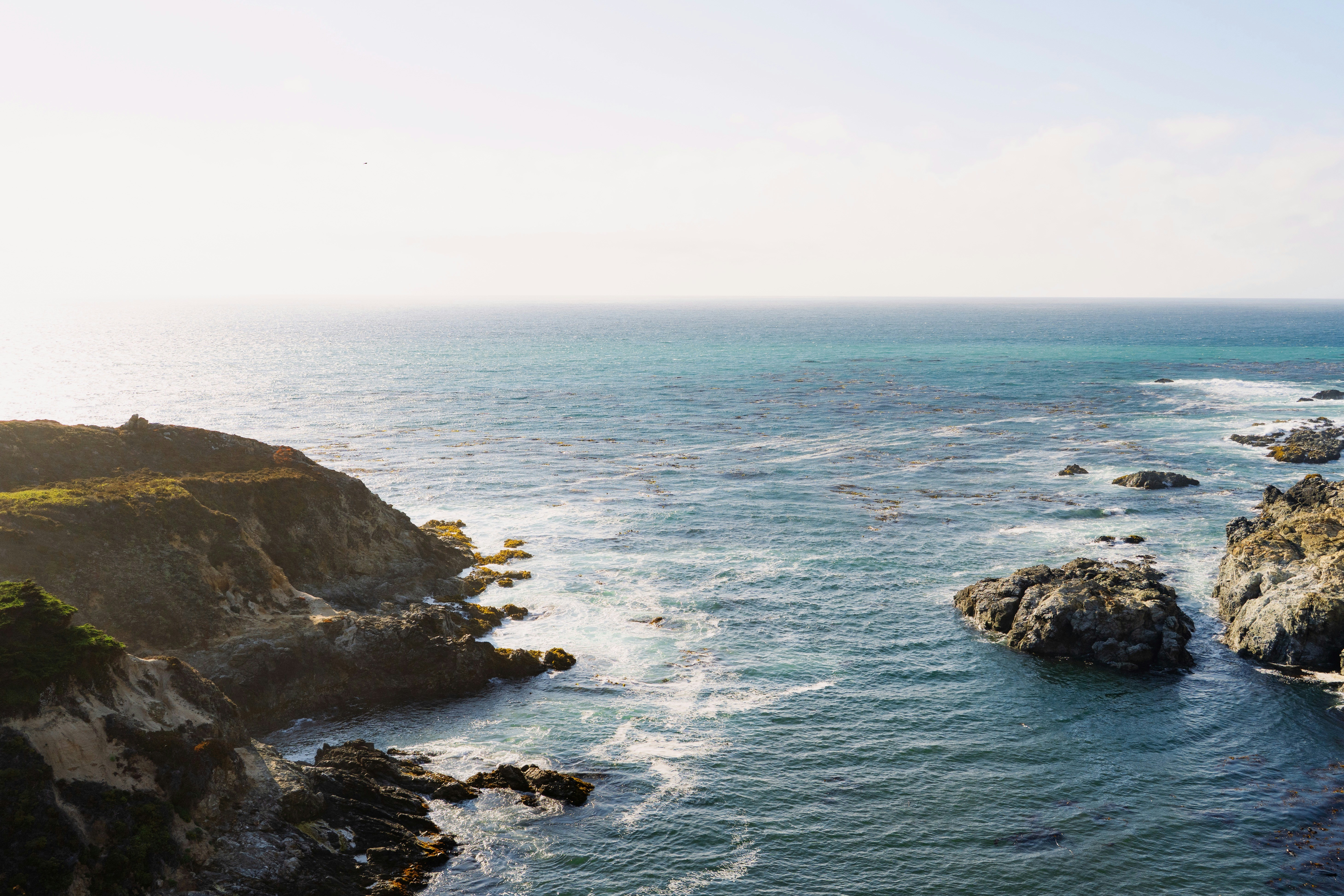 Rocky coastline with waves crashing on shore.