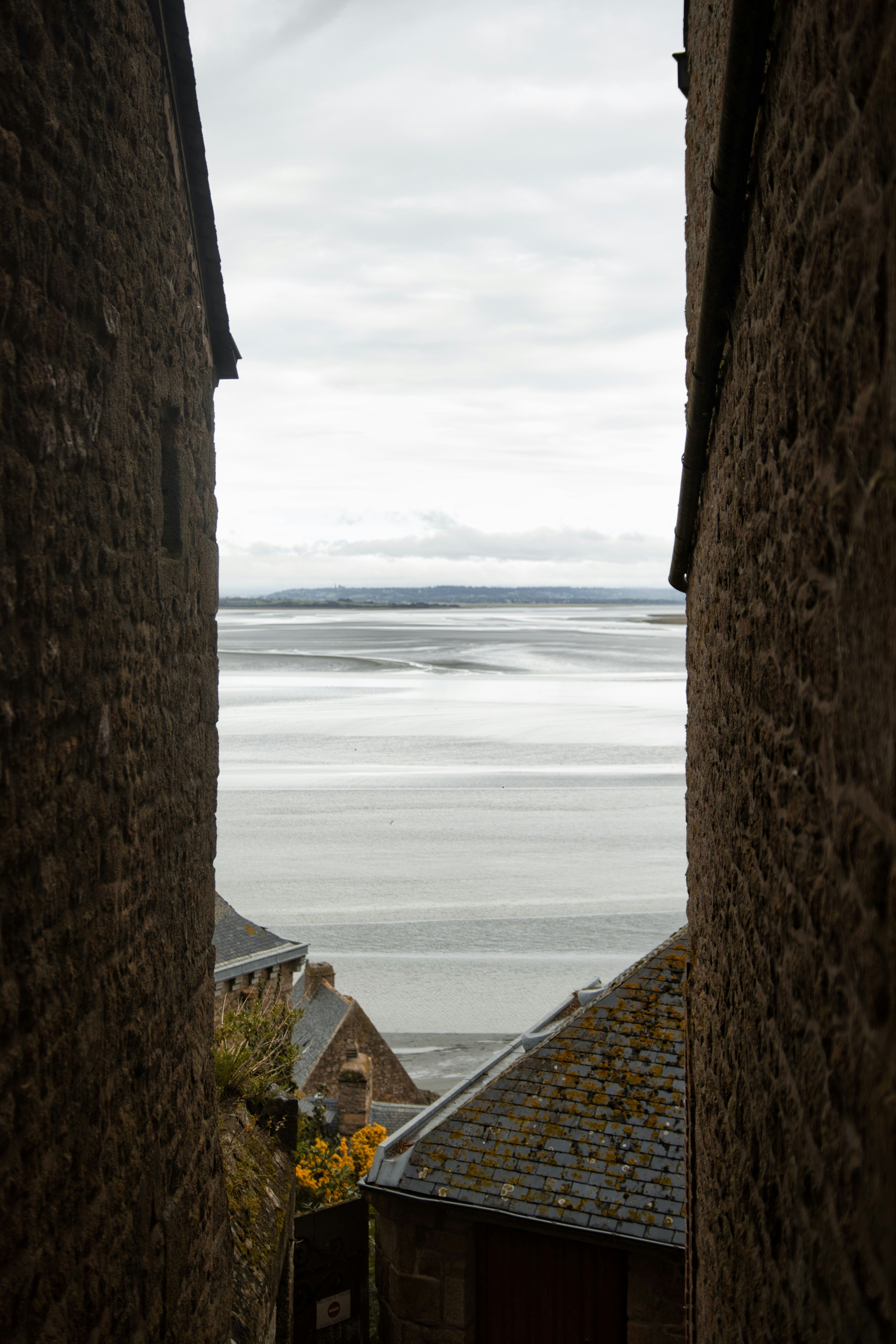Gateway to the Tidal Horizon: A Narrow Stone Corridor Framing the Sea