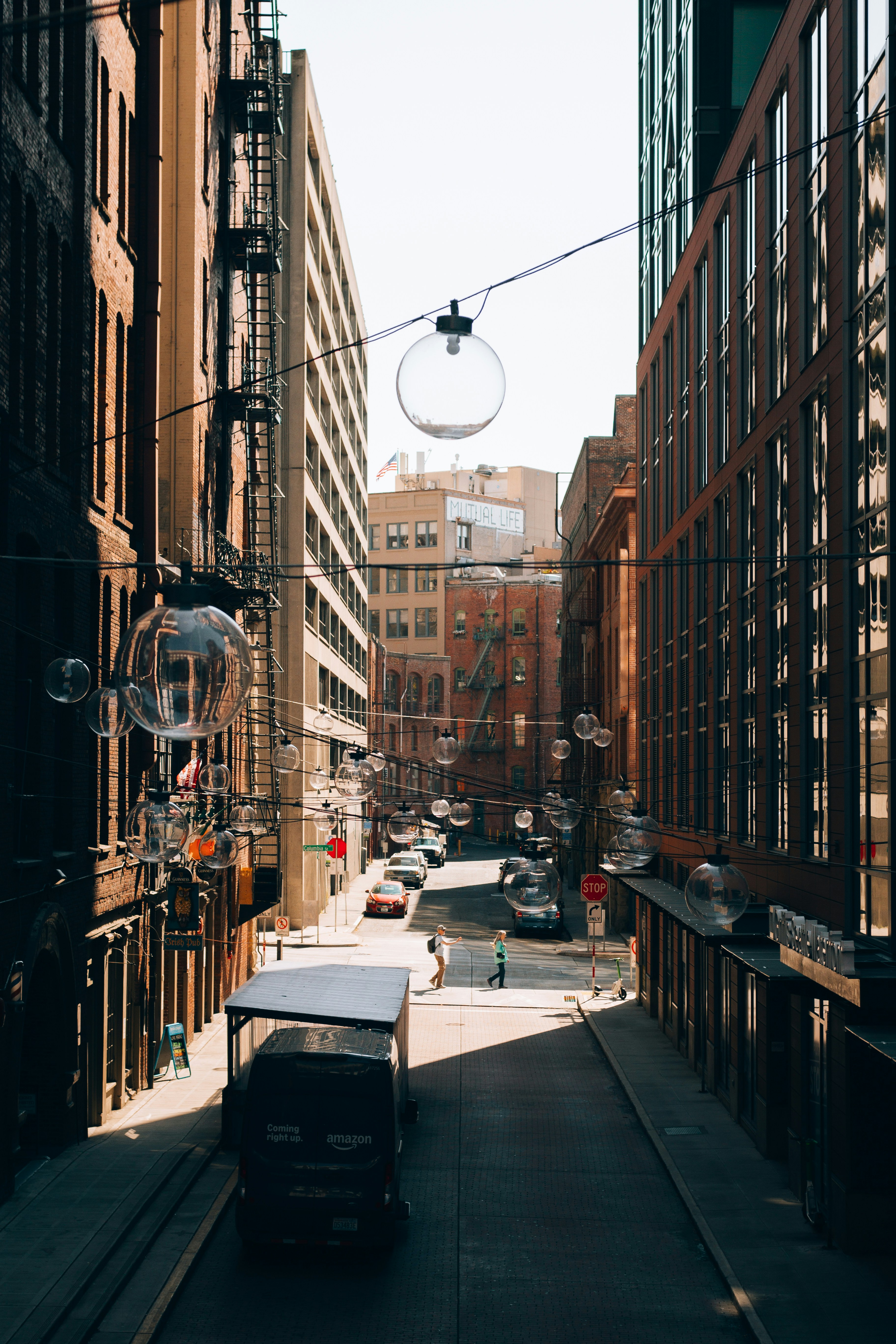 City street with buildings and decorative spheres.