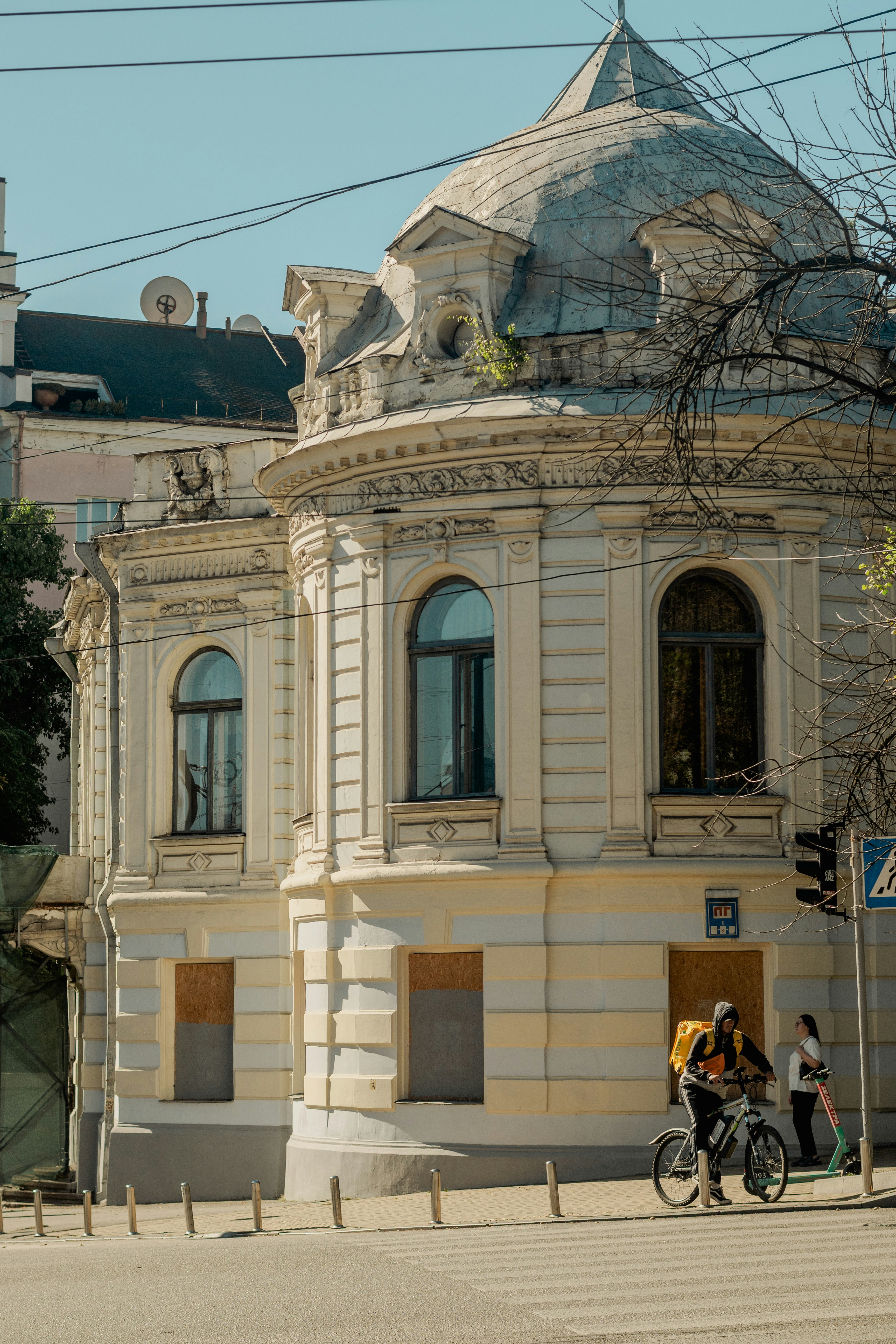 Ornate building with a domed roof and people on street