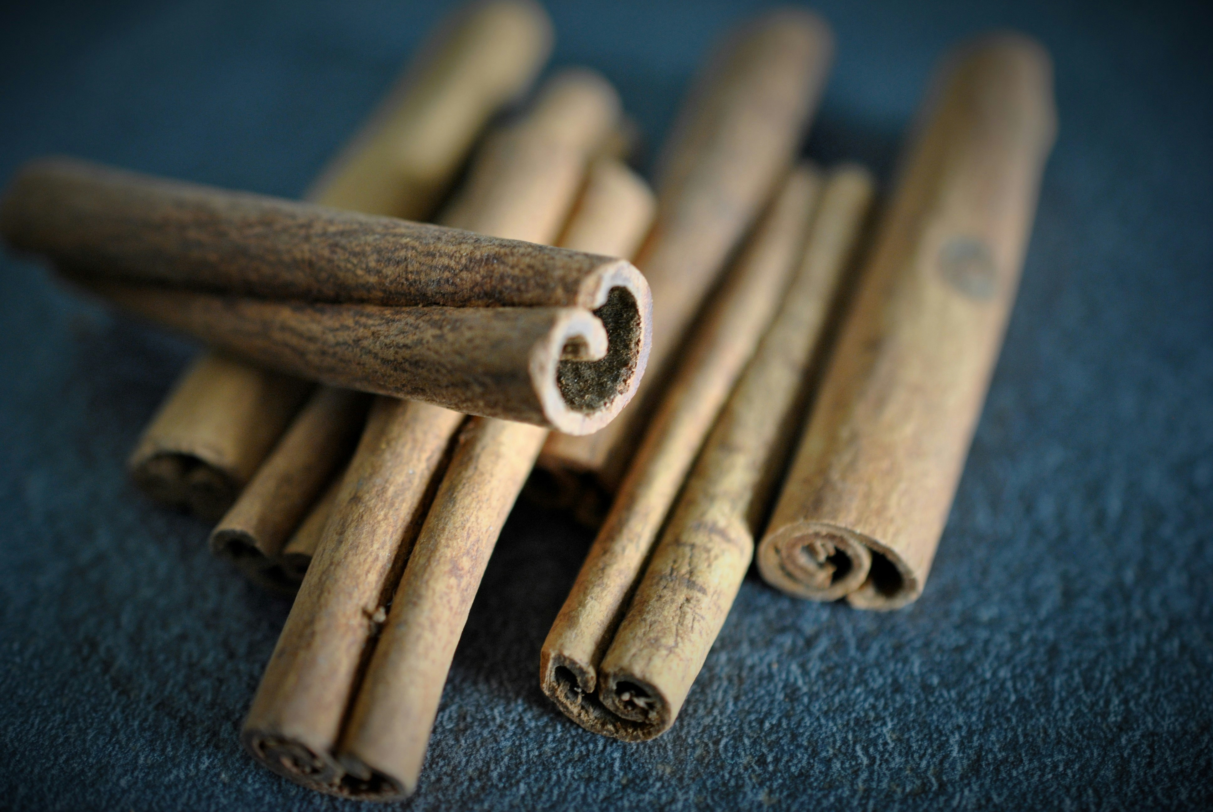 A close-up arrangement of cinnamon sticks showcasing their rich textures and natural curls.