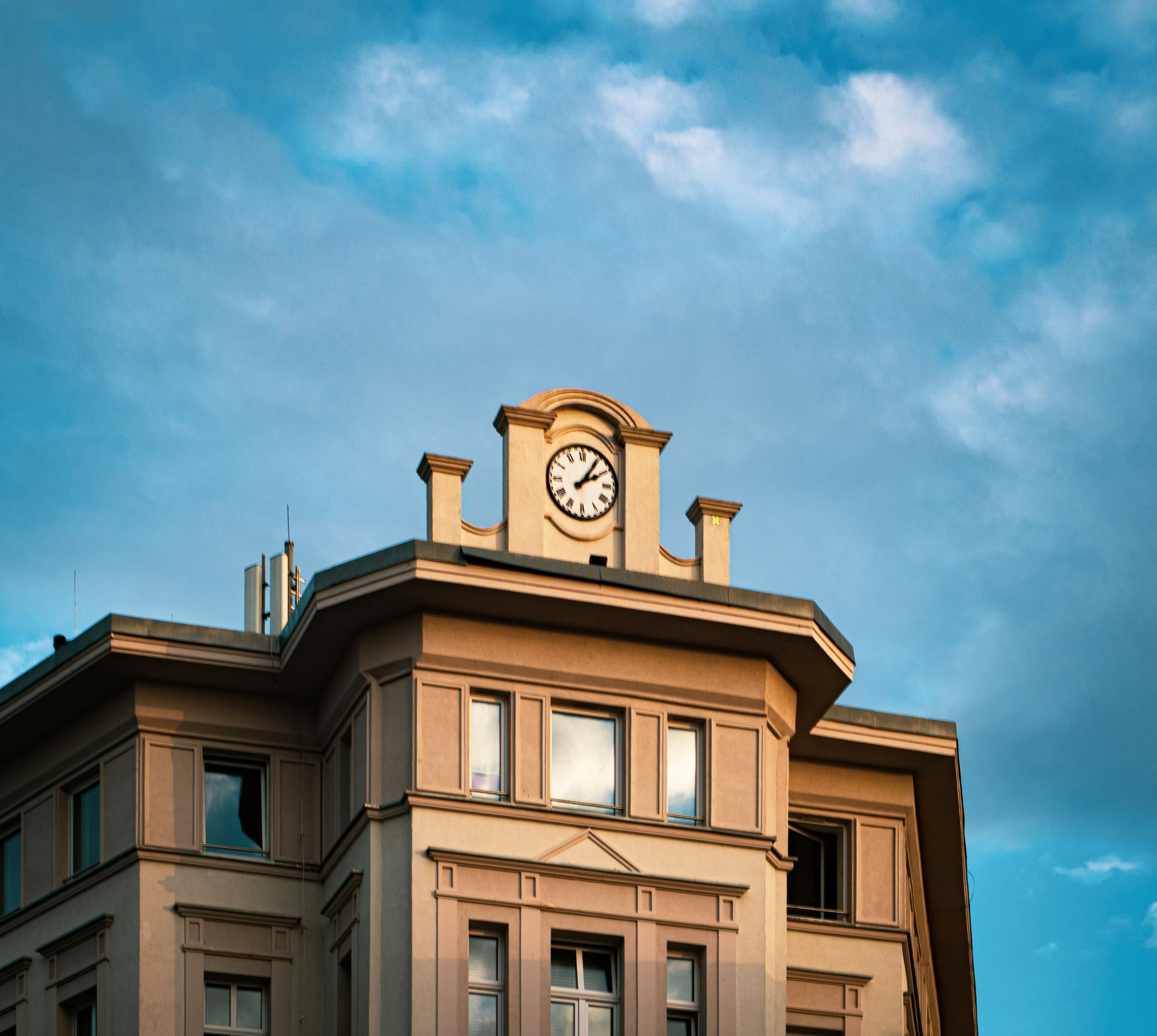 Building facade with a clock under a blue sky
