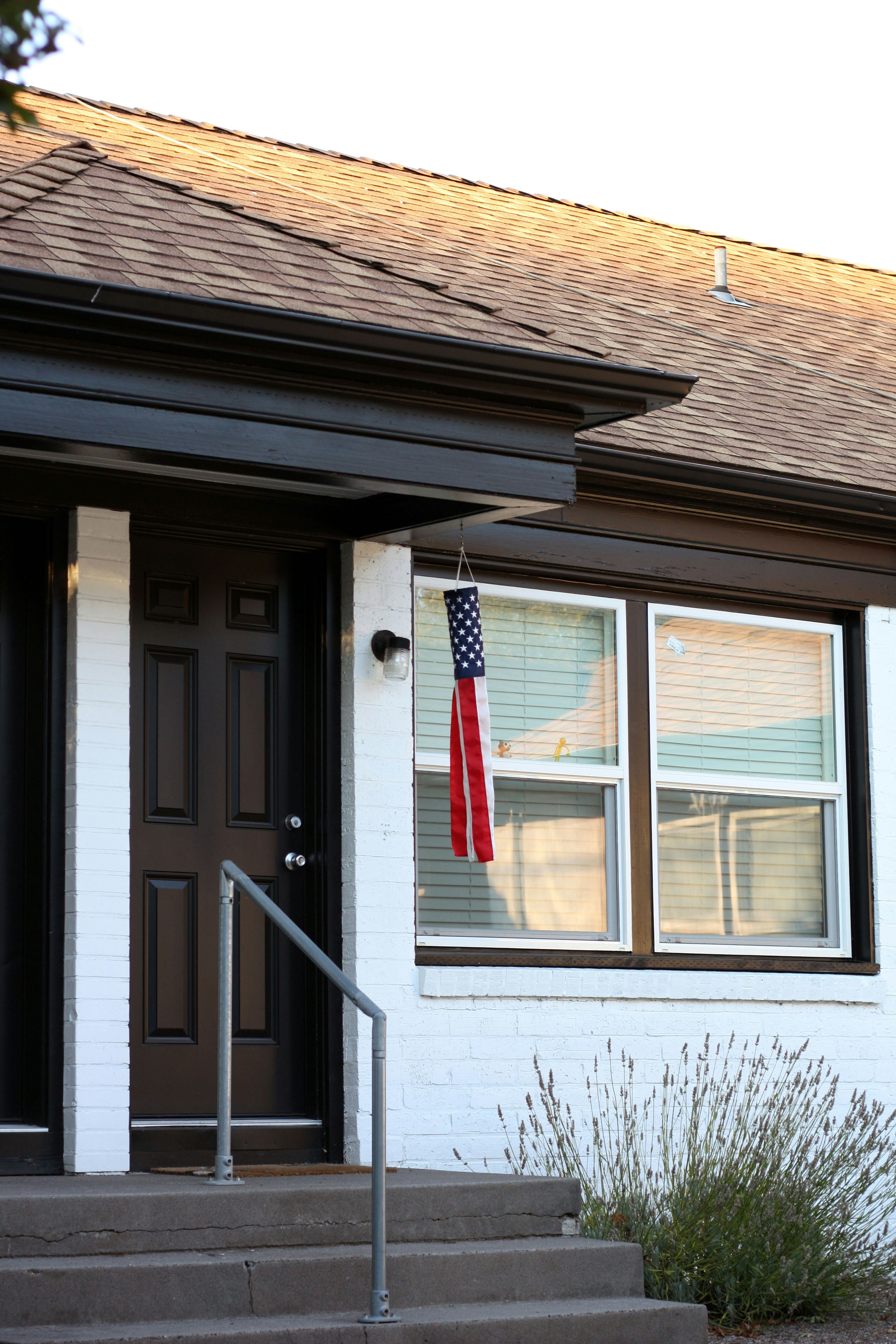 American flag hanging by a house entrance.