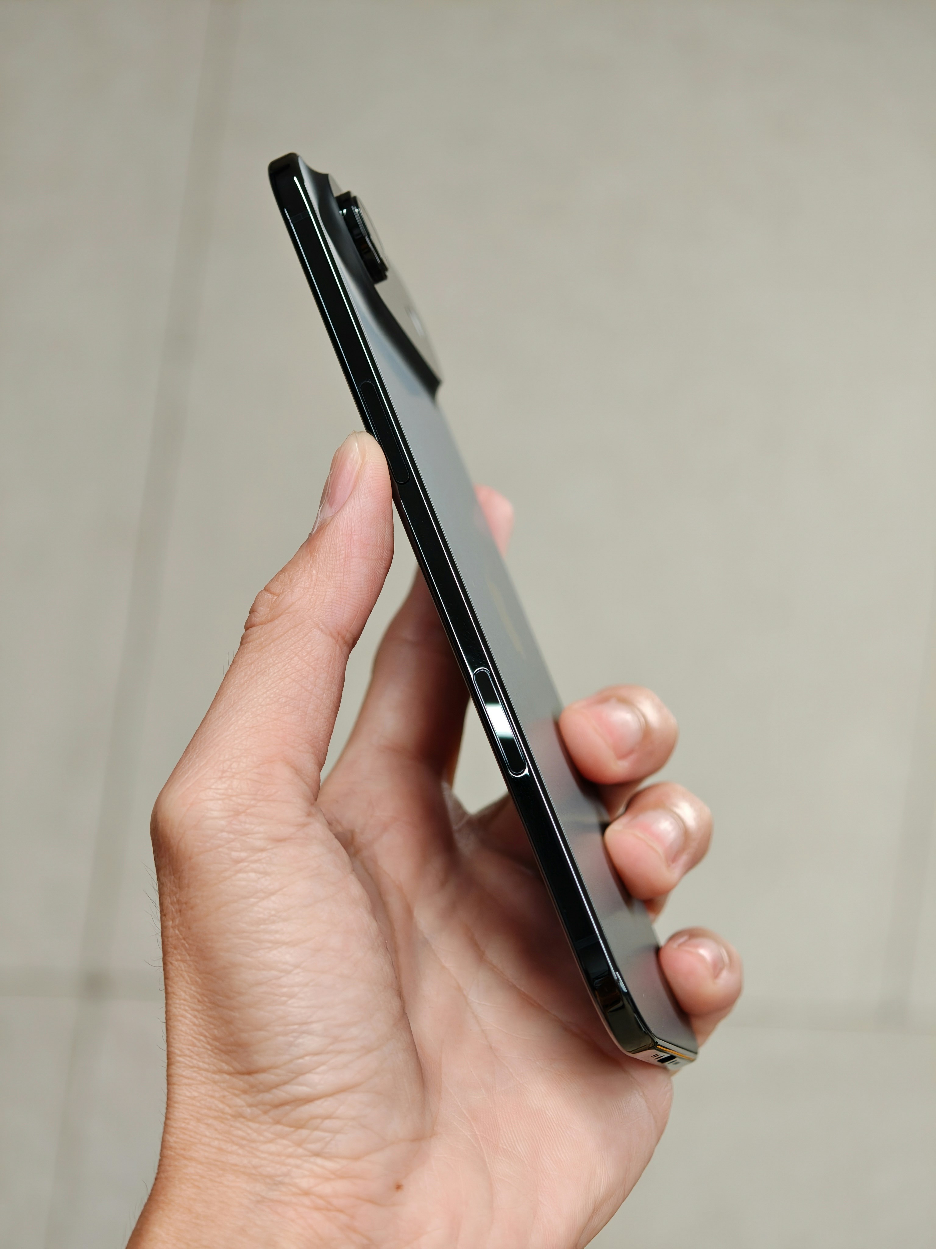 iPhone Air Space Black | Hand holding a black smartphone from the side.