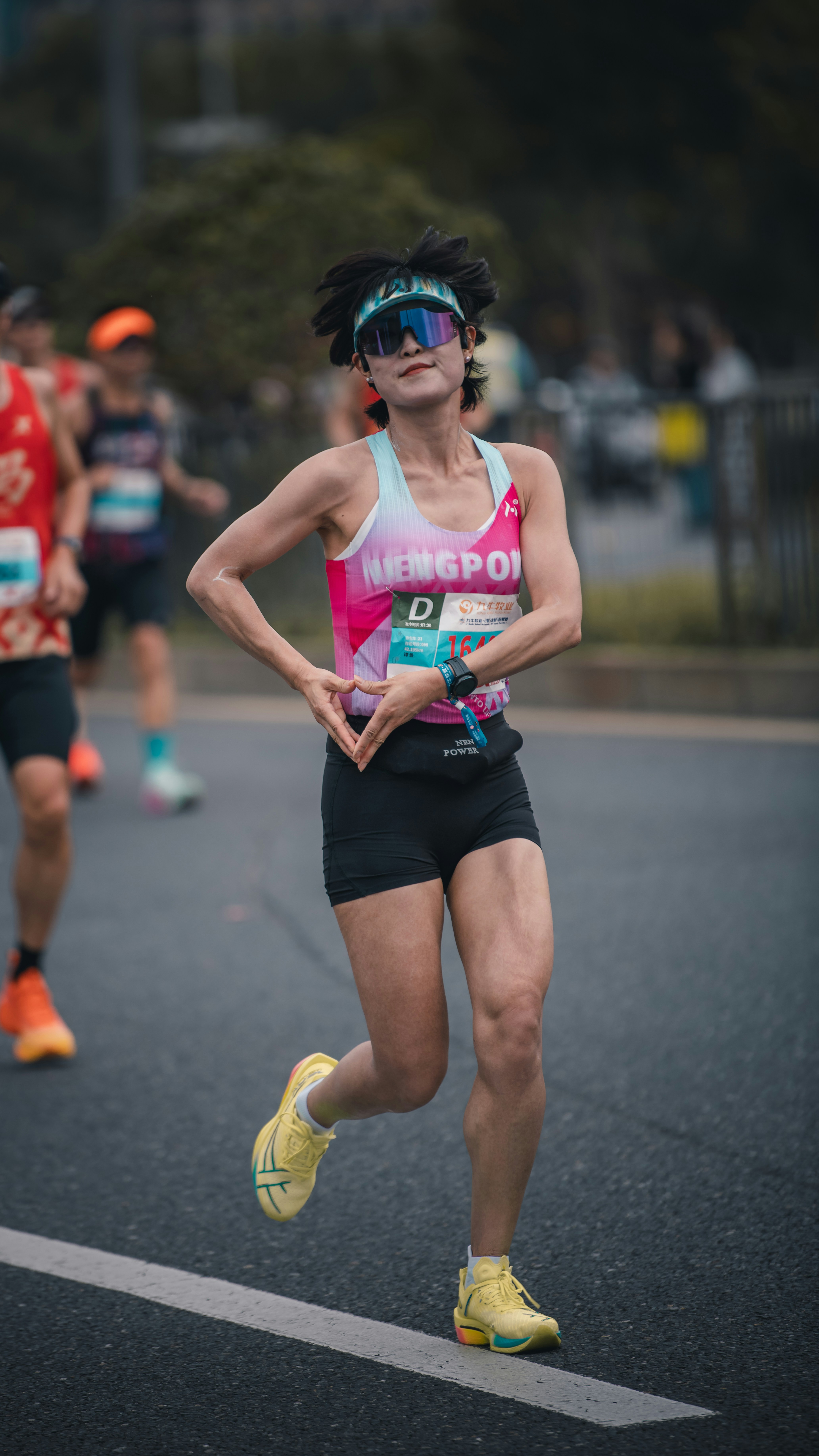 Runner forms heart shape with hands during race. photo – Free ...