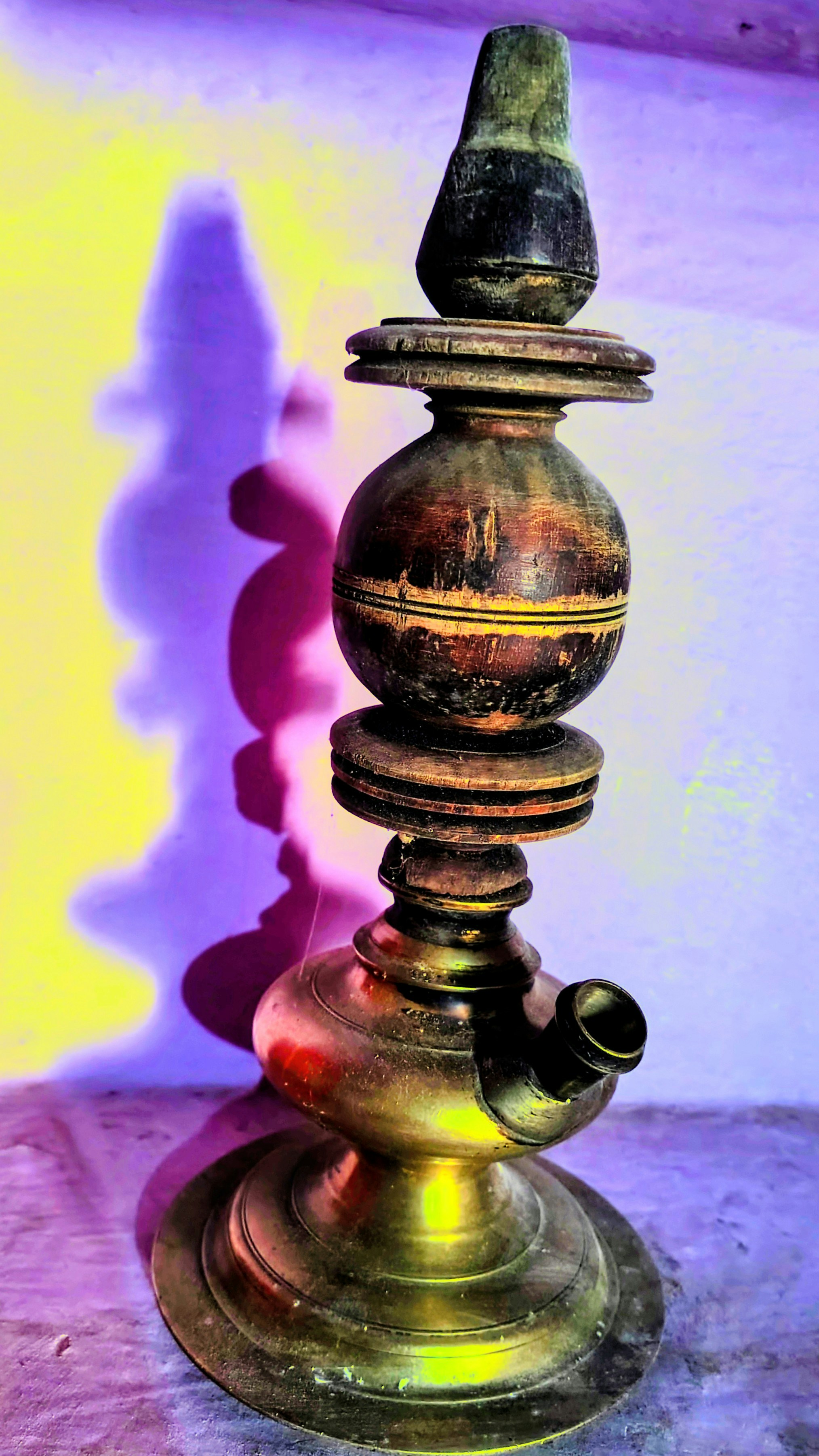 Have you tried it ever😉 | An antique brass and wood oil lamp with a shadow.