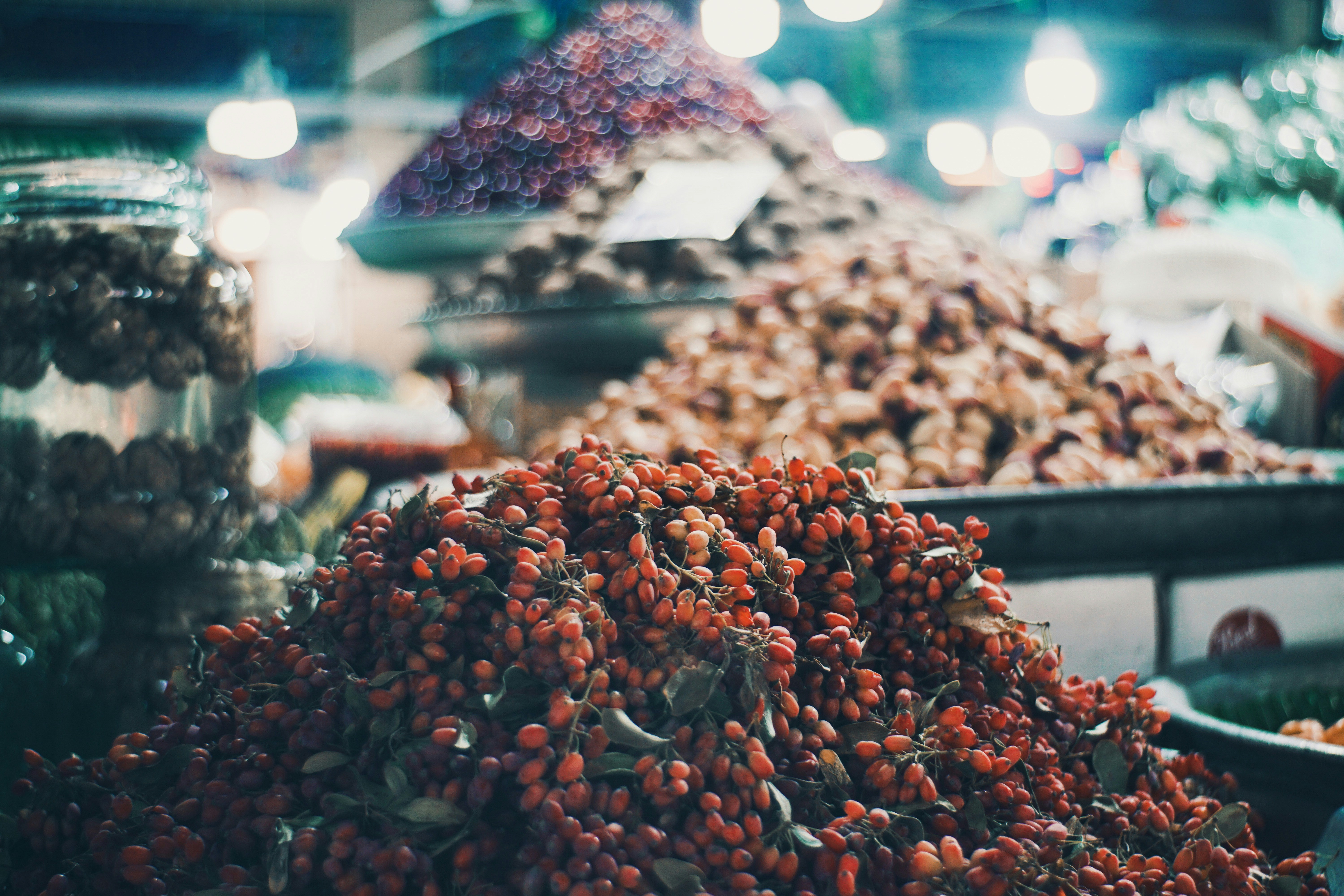 Little red jewels of the Persian kitchen. | Piles of dried berries and nuts at a market.