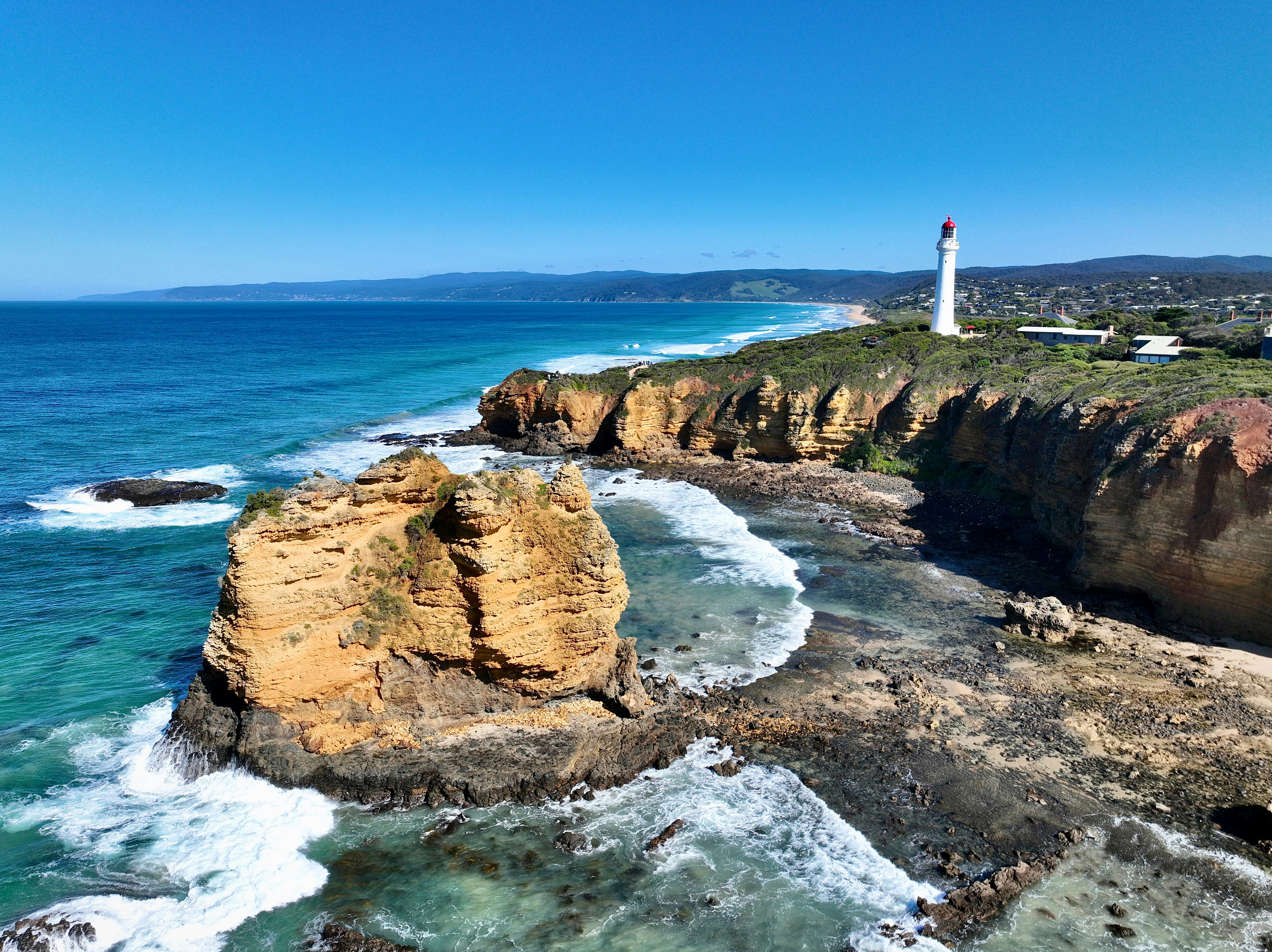 Guardian of the Shoreline: A Lighthouse Amidst Nature's Splendor
