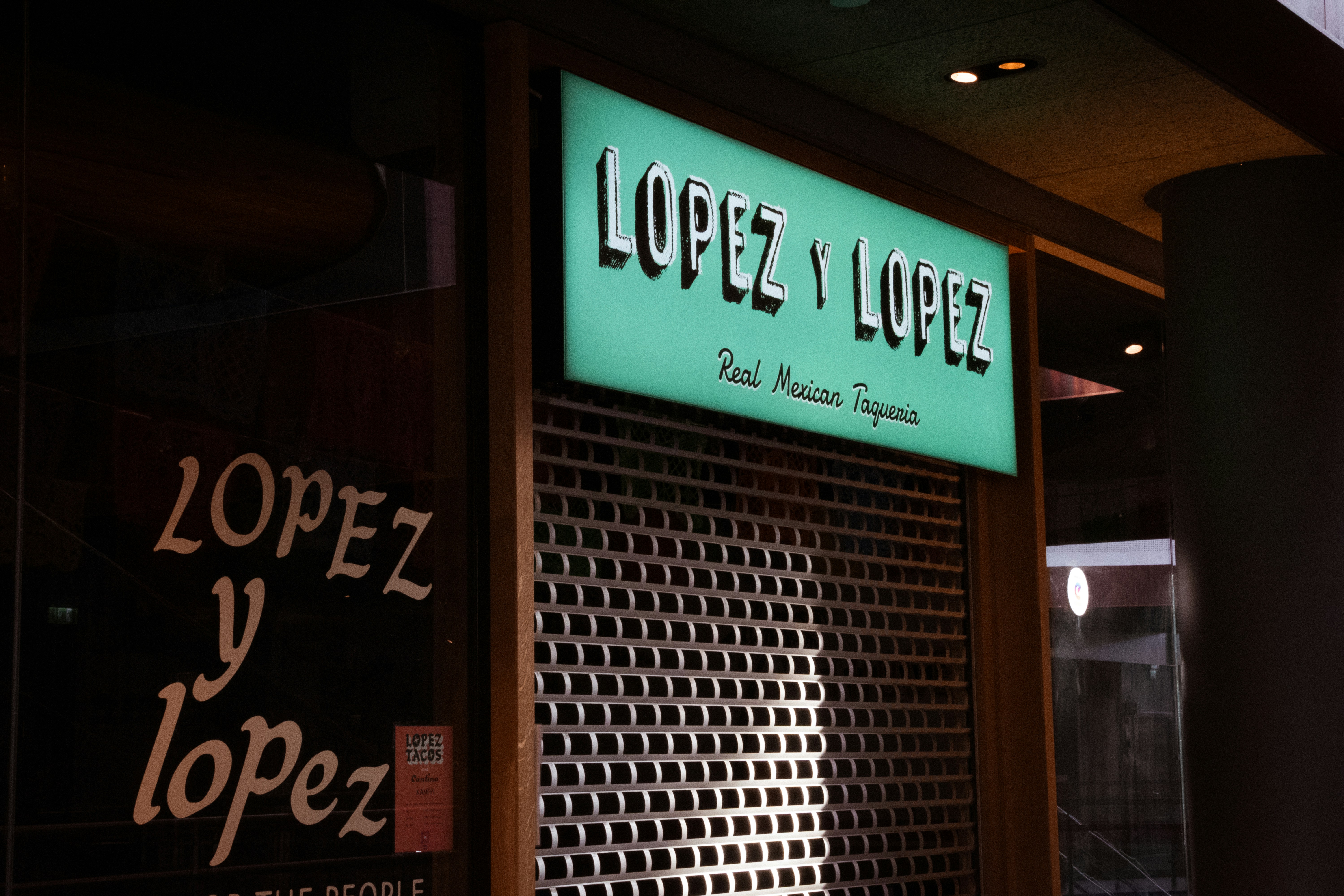 Lopez y Lopez taqueria restaurant in Kamppi, Helsinki. | Lopez y lopez restaurant storefront at night with closed shutters
