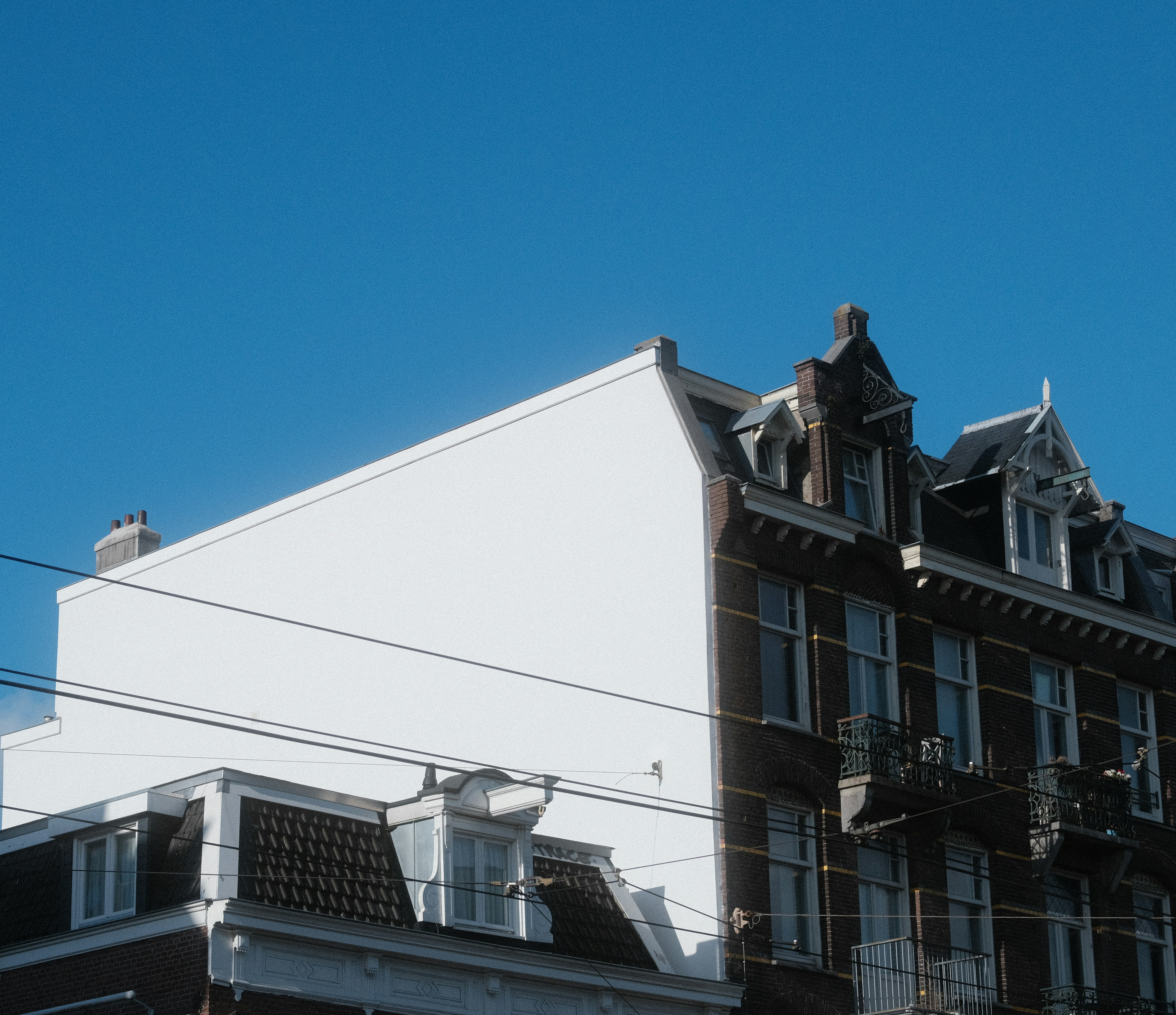 A incredible bright white facade in Amsterdam. | Historic buildings against a clear blue sky