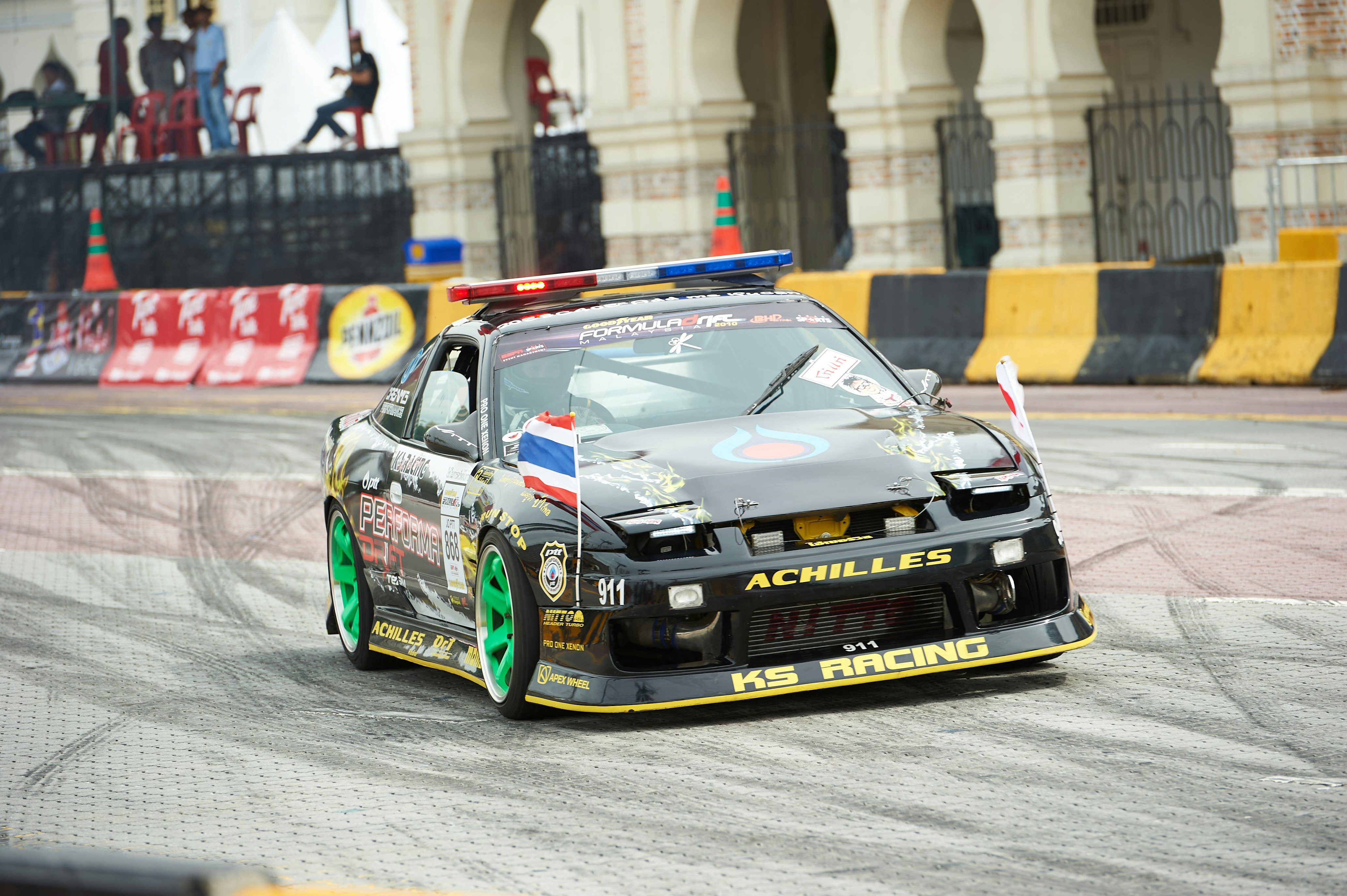 A black drift car with green wheels on a track photo – Free Sports car ...