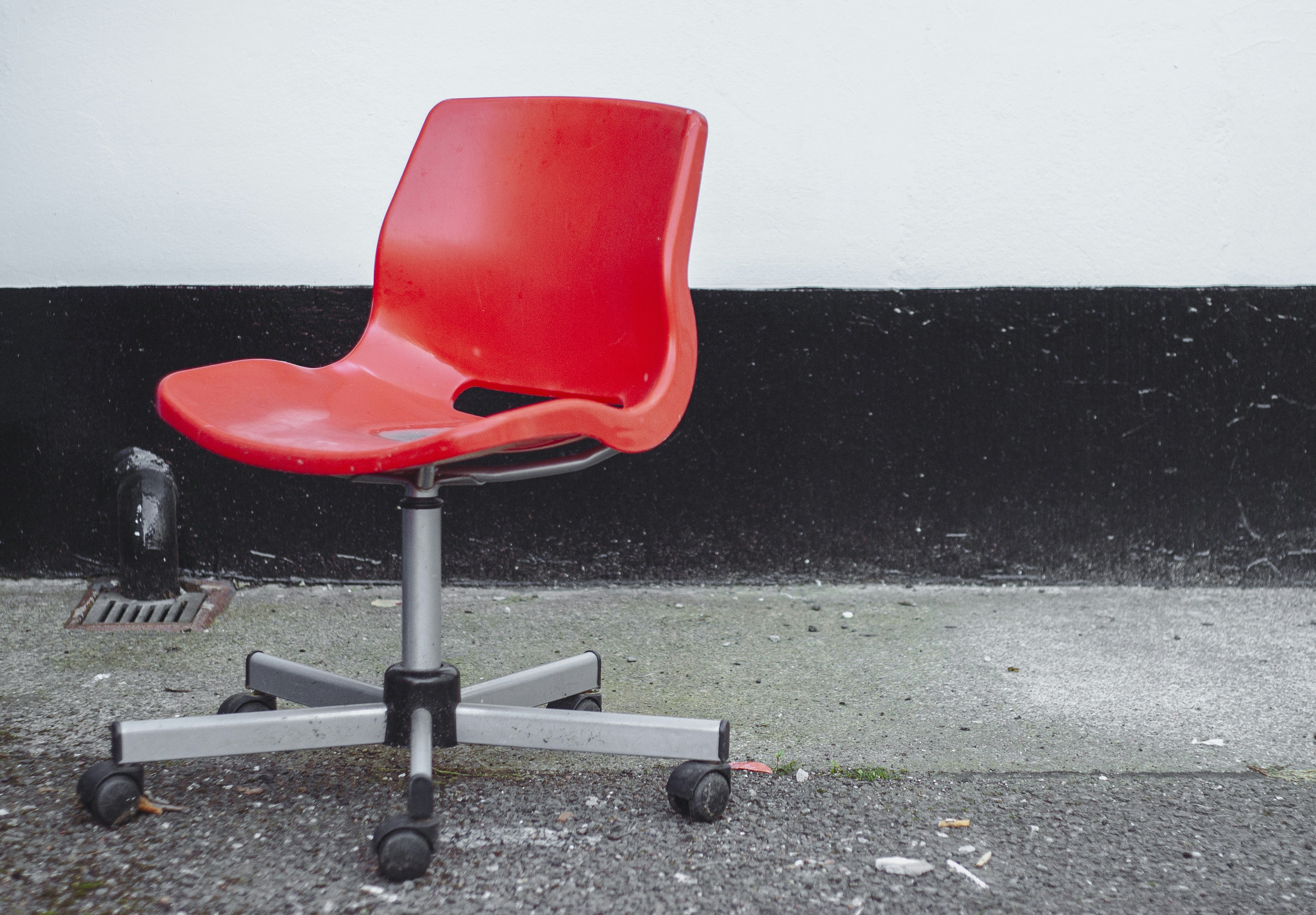 SONY DSC | A red office chair on a concrete floor