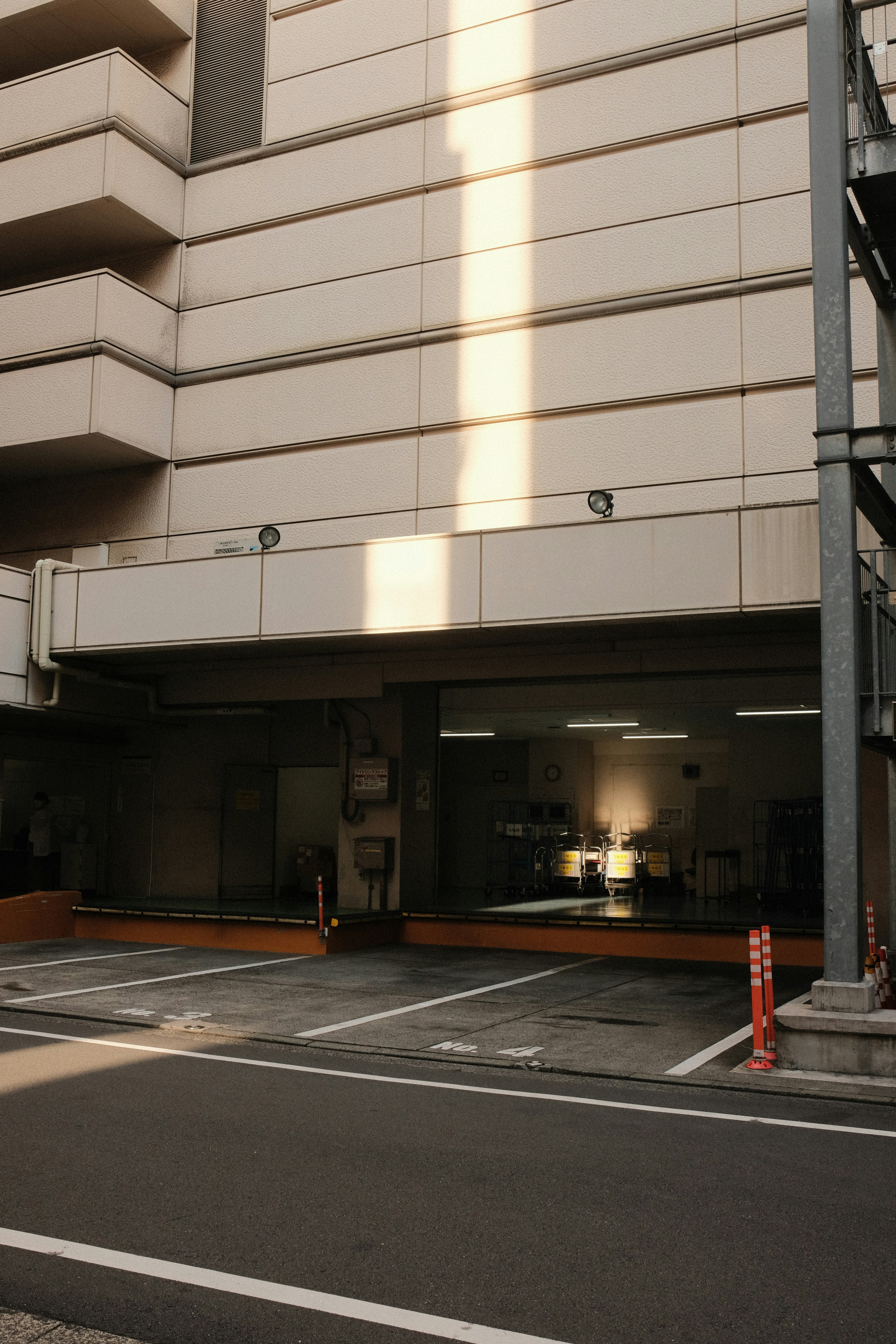 Modern building entrance with sunlit facade.