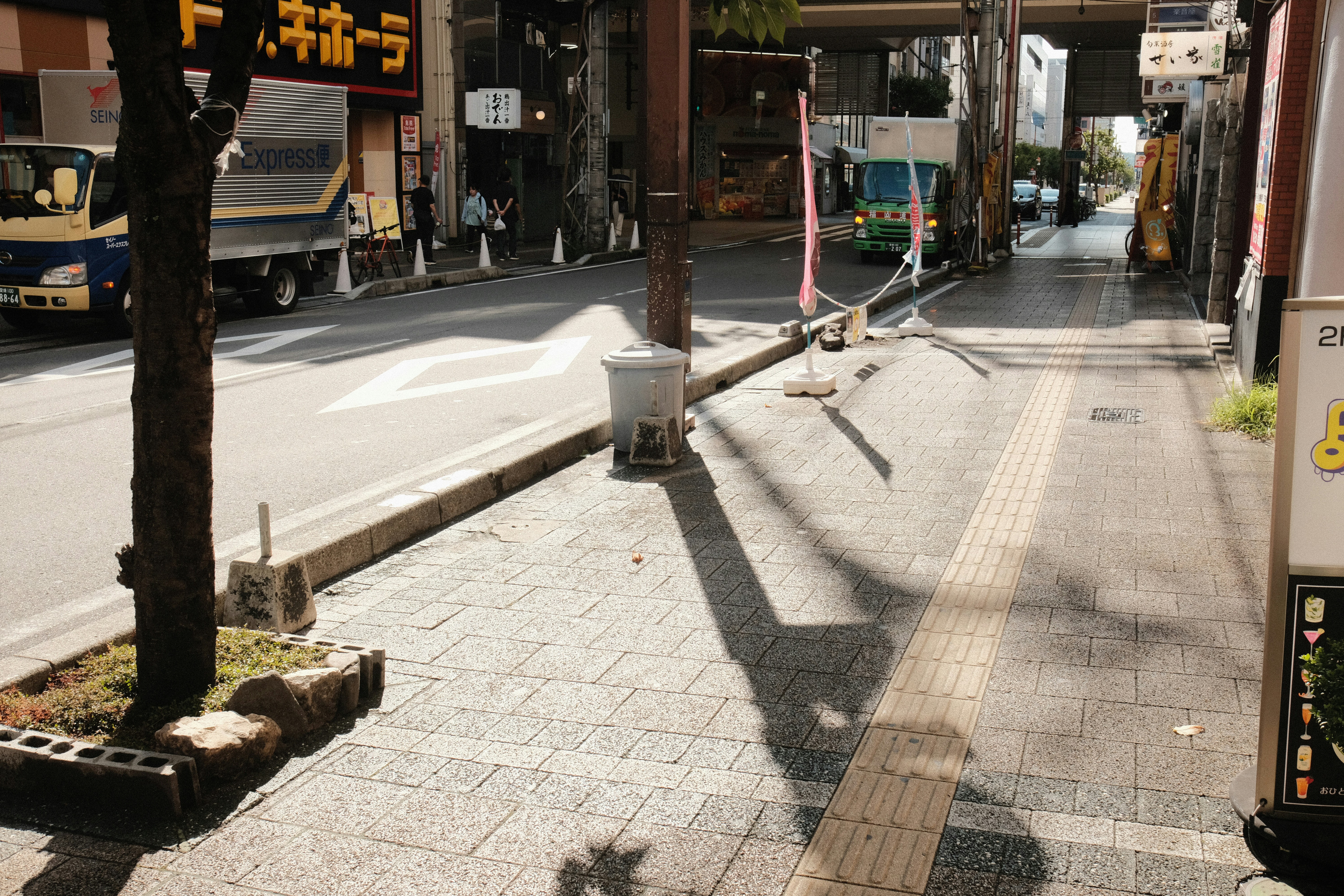 Street scene with a sidewalk and buildings.
