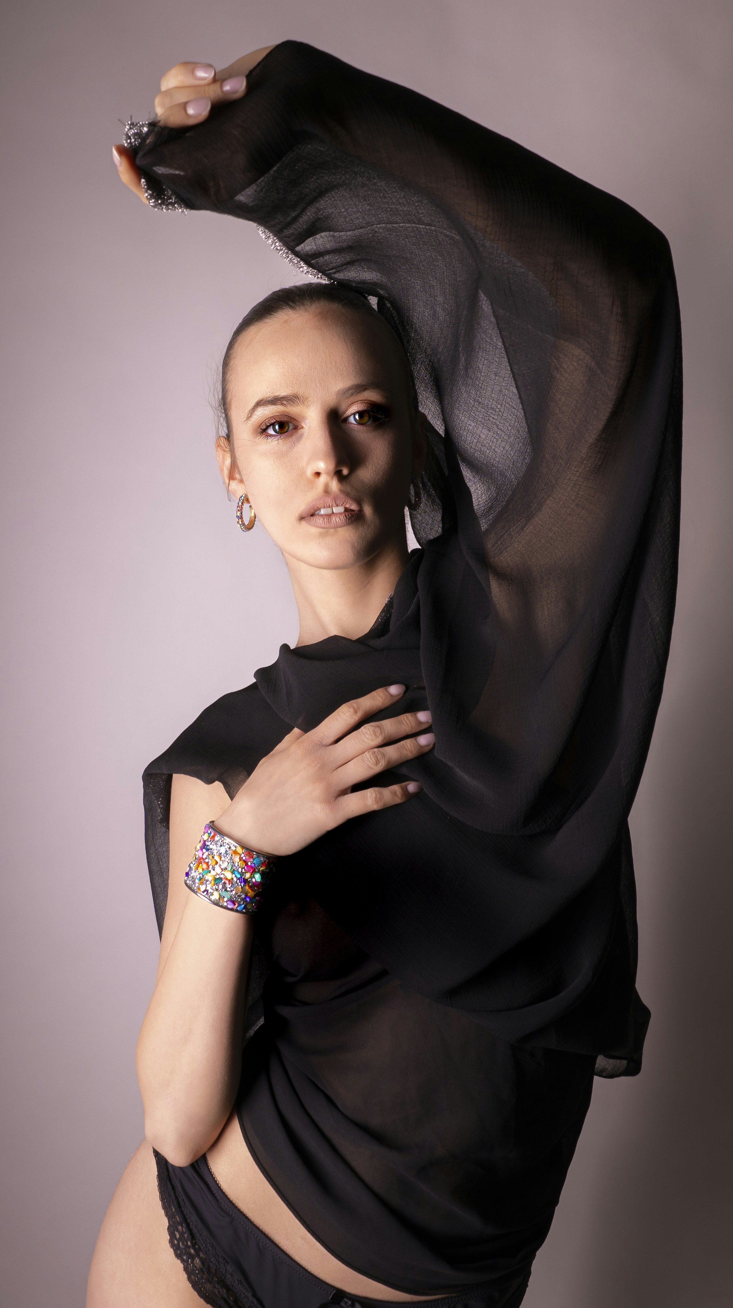 Woman in black sheer fabric and jewelry