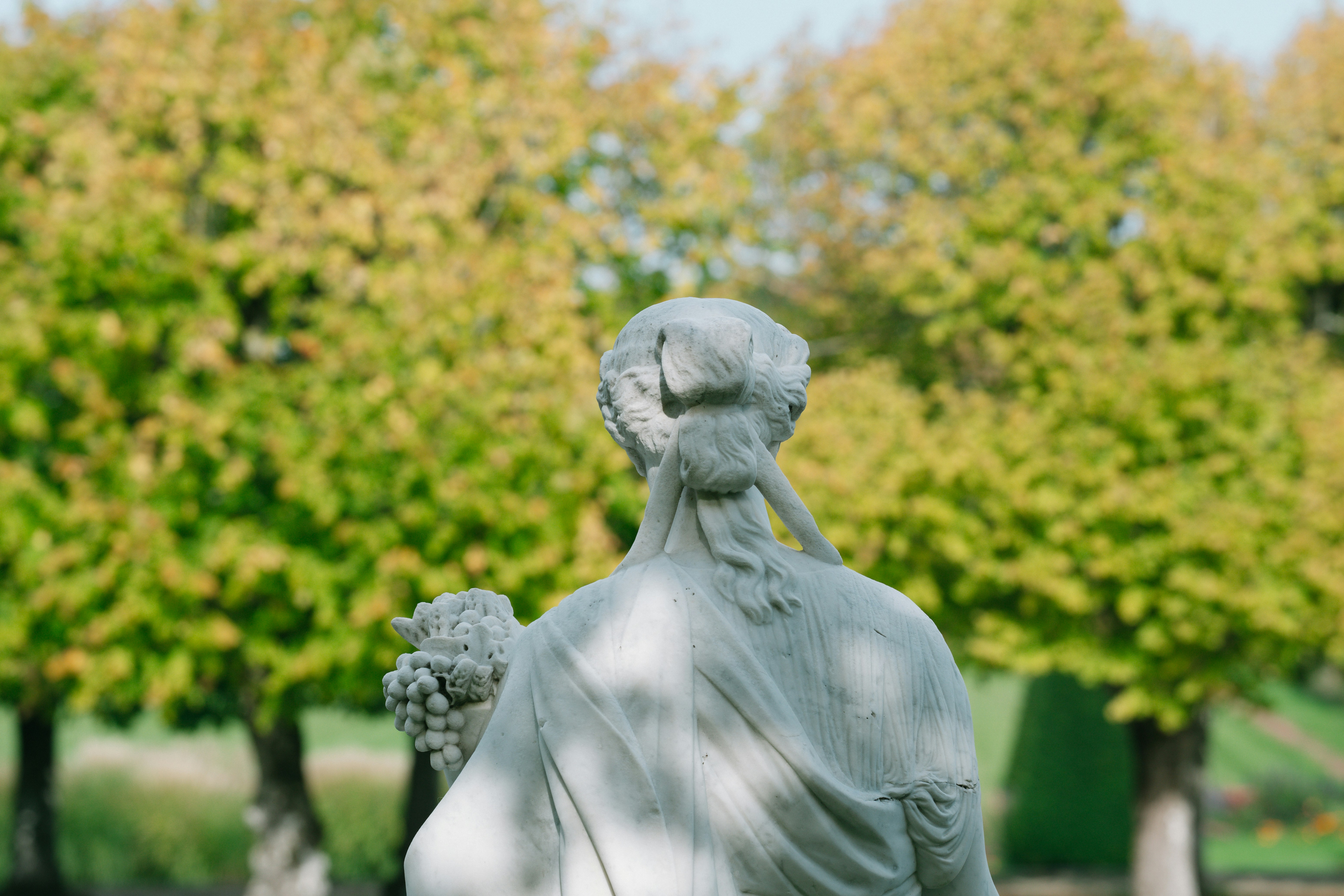 Stone statue in a park with trees