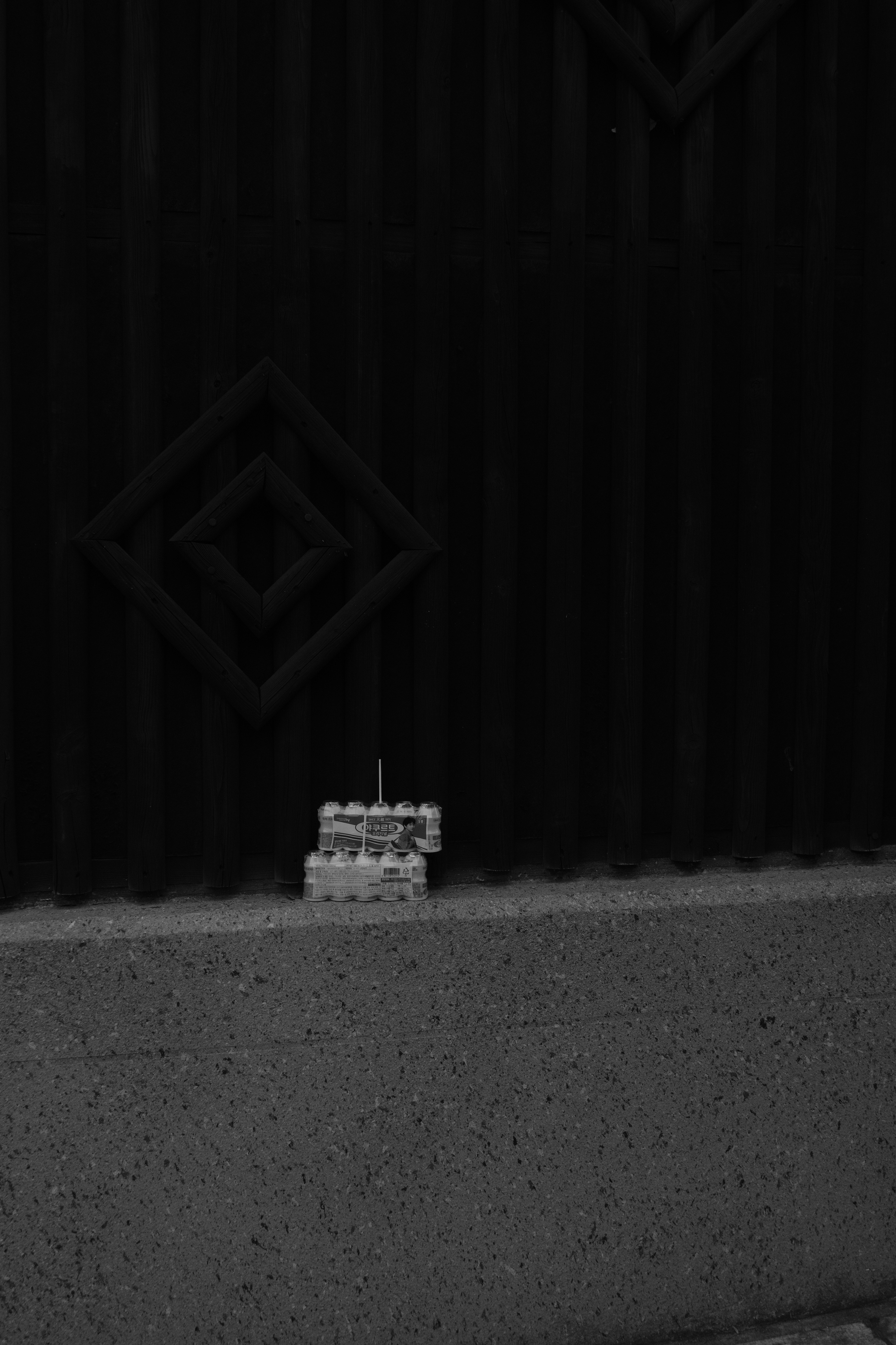 Small toy robot on a concrete ledge.