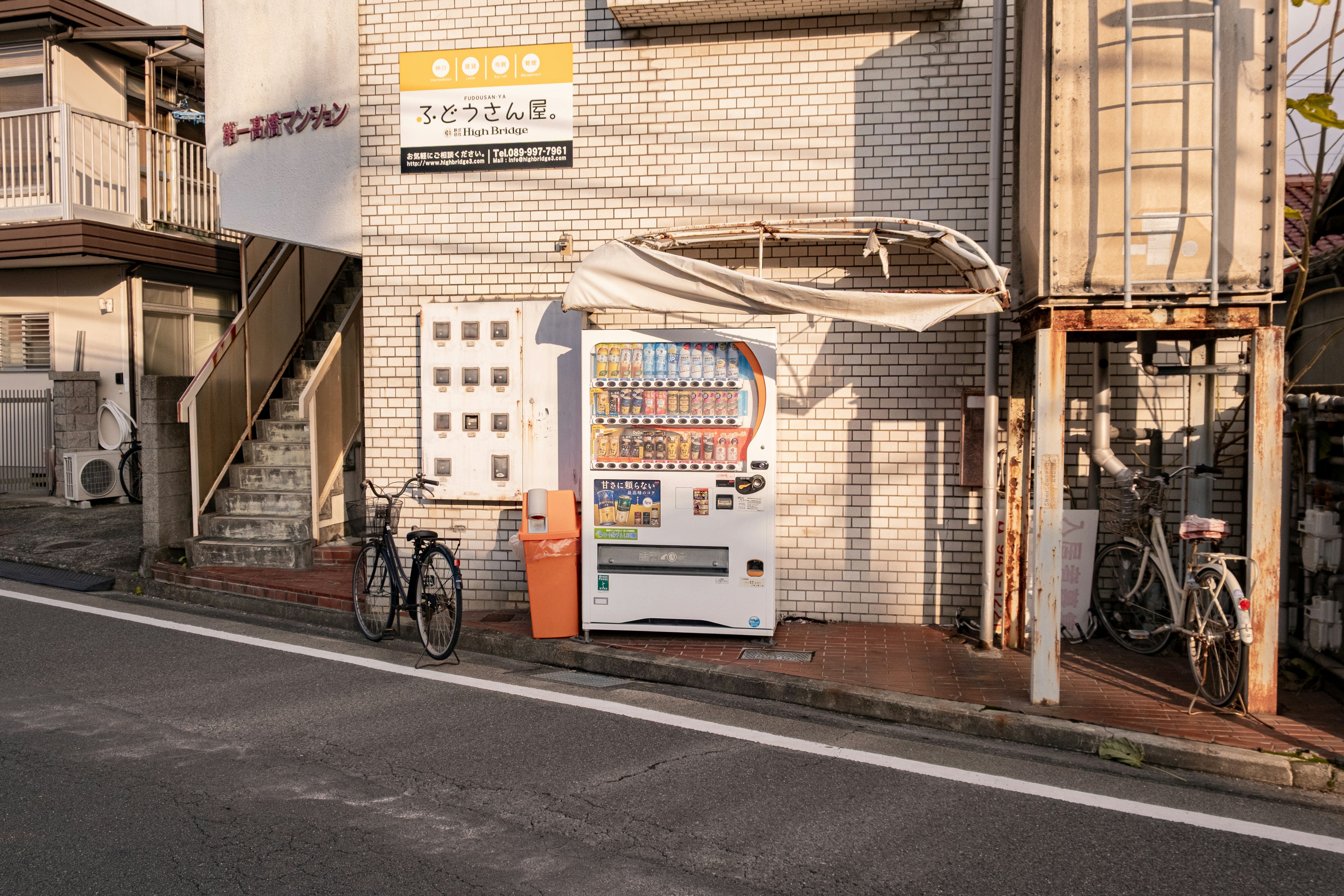 Vending machine and bicycles on a street.