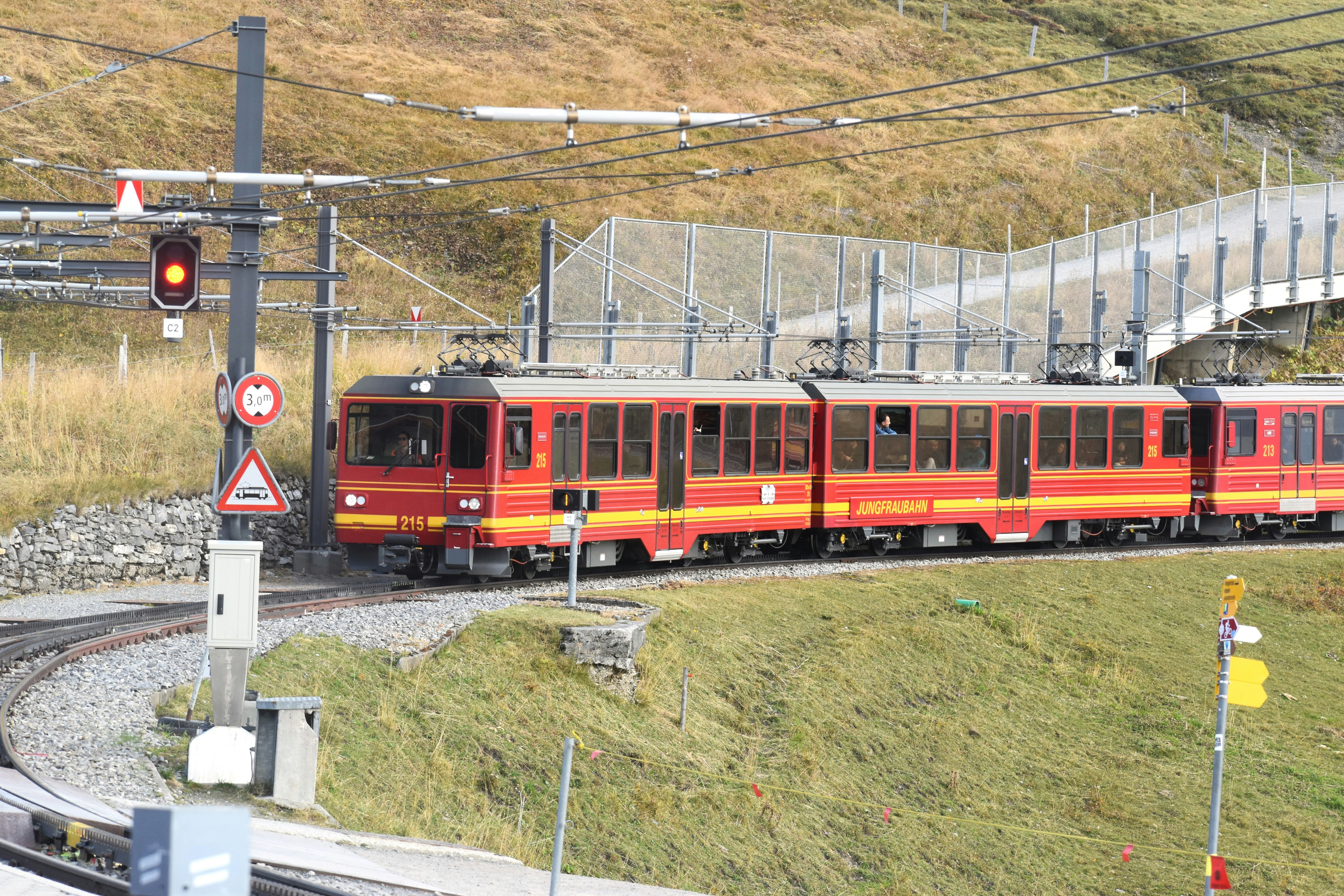 Swiss Mountain Train | Red train traveling on a scenic mountain track