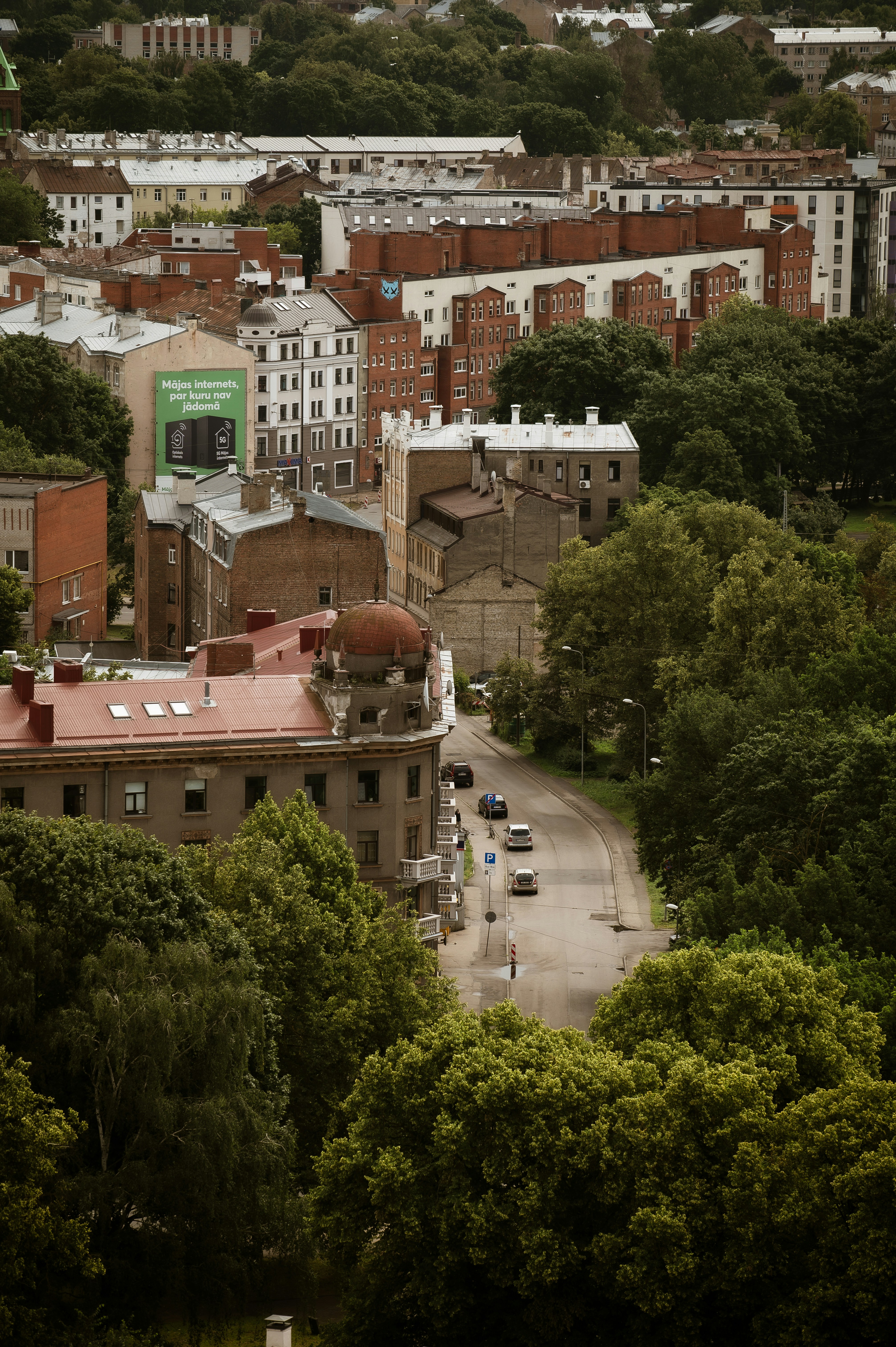 City street winding through trees and buildings