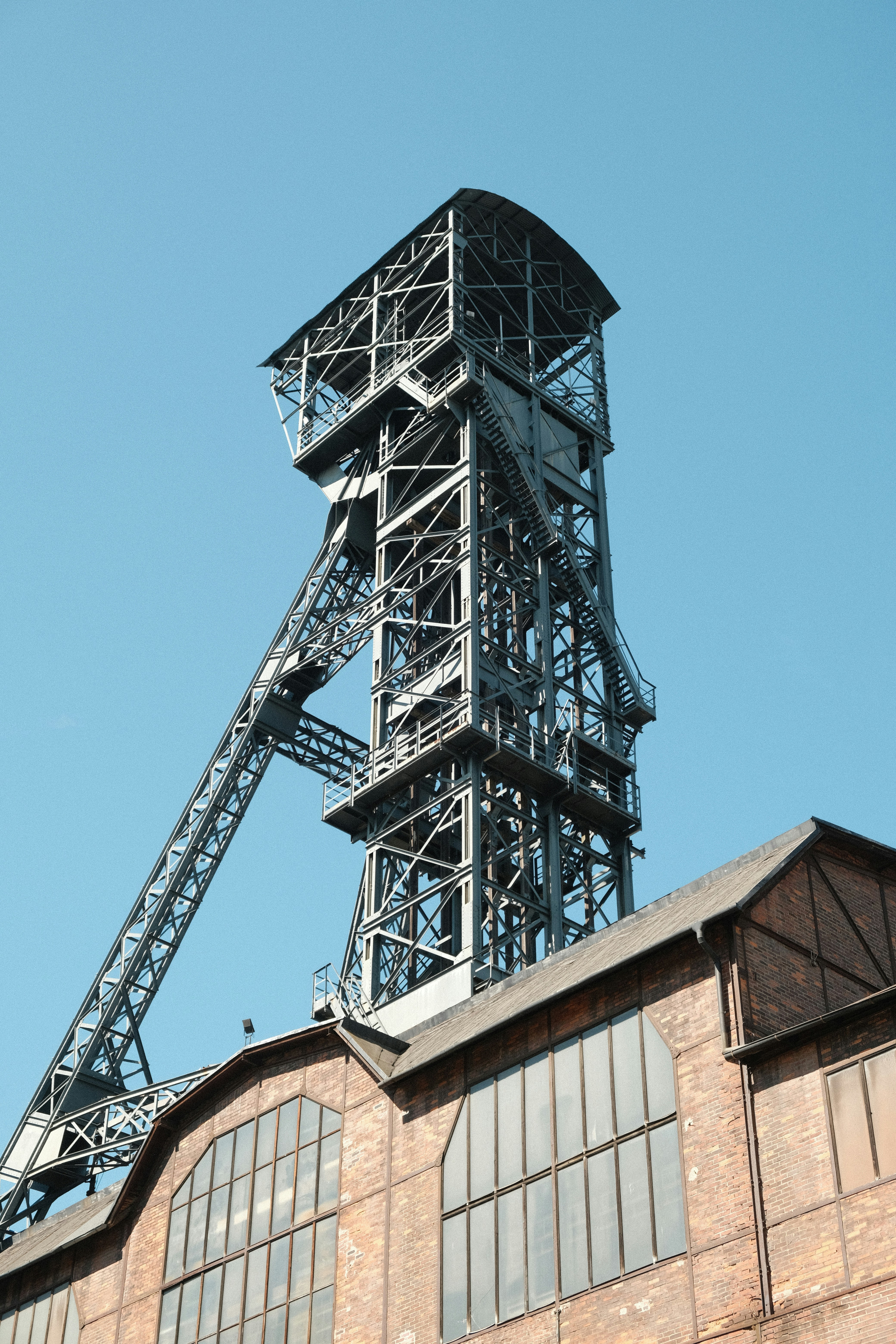 Industrial mining tower against a clear blue sky