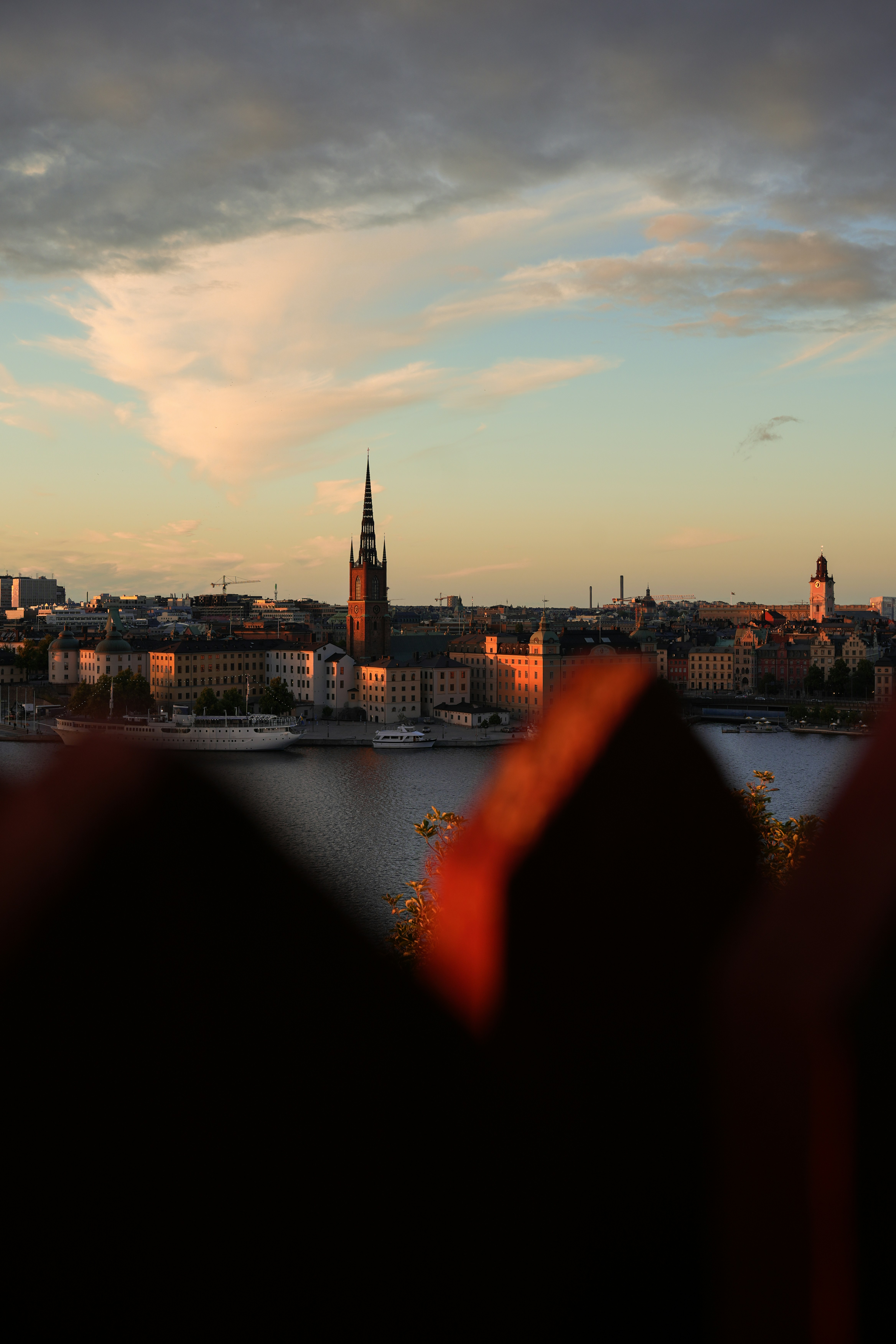 City skyline at sunset with a prominent church spire.